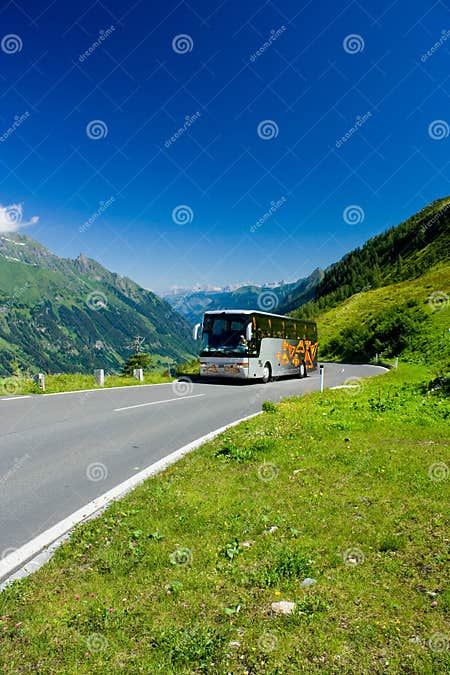 Bus on a road in Alps stock image. Image of metal, orange - 5915903
