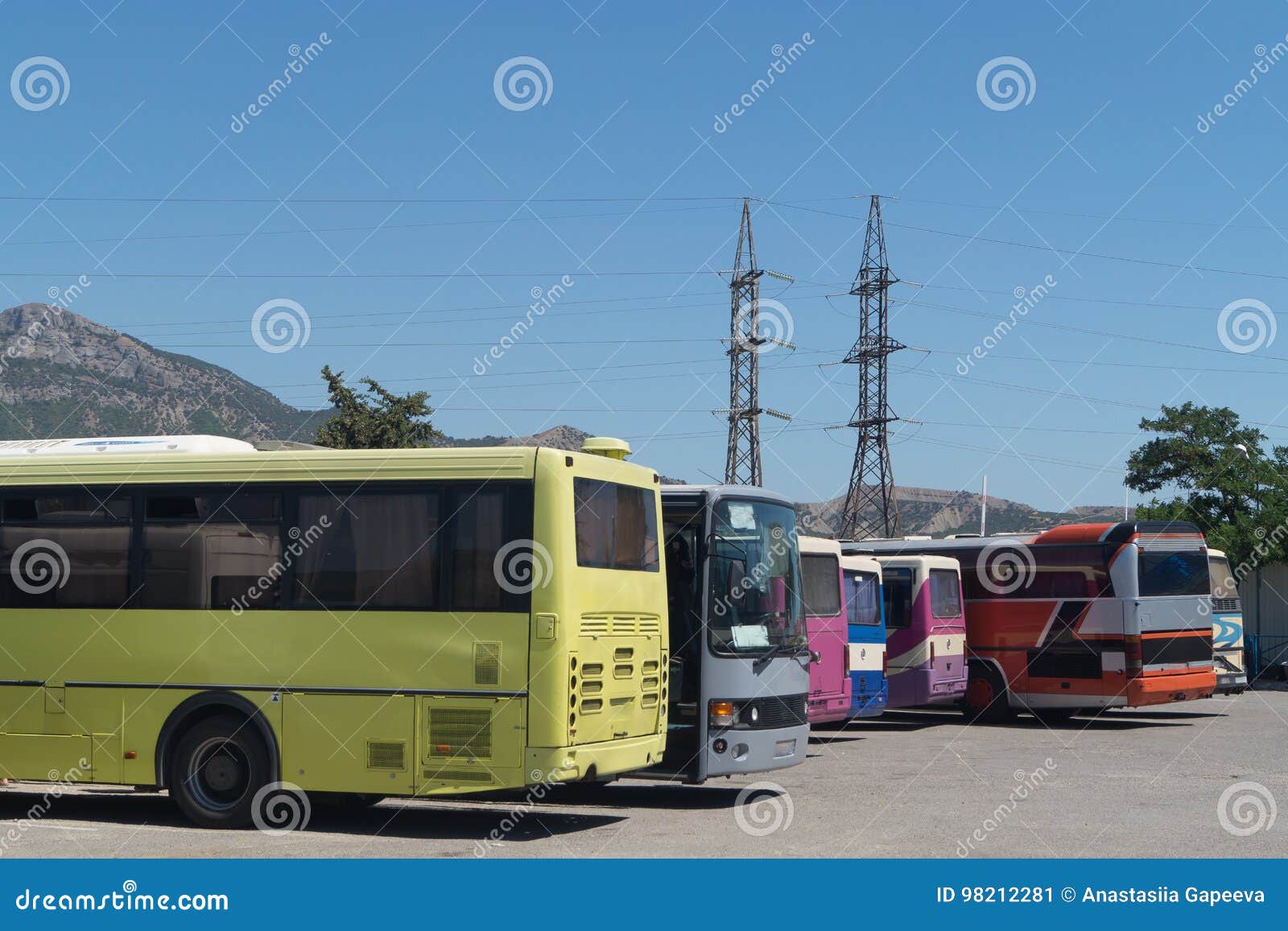 Bus Station with Colorful Buses. Two Electric Posts on the Background ...