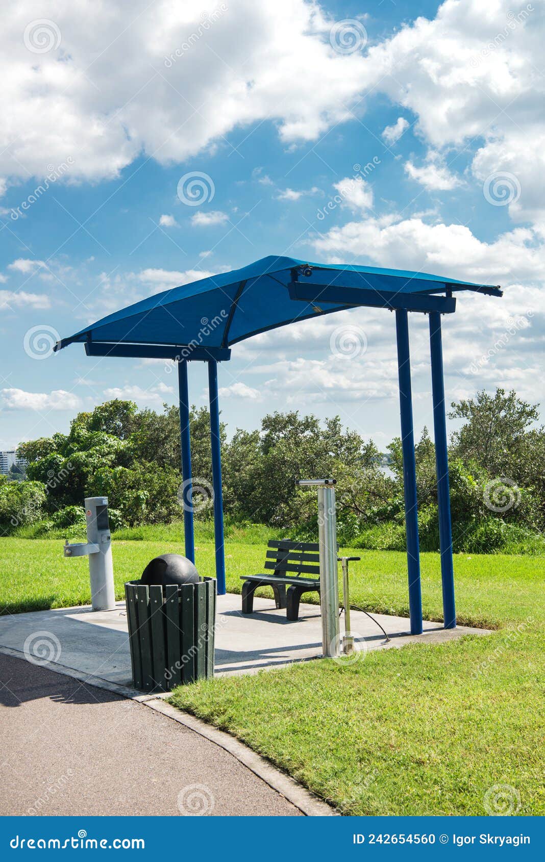 Bus Stop with a Canopy and a Drinker. Green Lawn and Blue Sky Stock ...