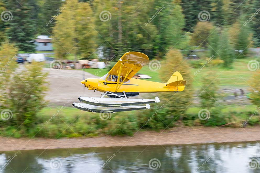 Bush Float Plane Flying Over River in Alaska Stock Photo - Image of ...