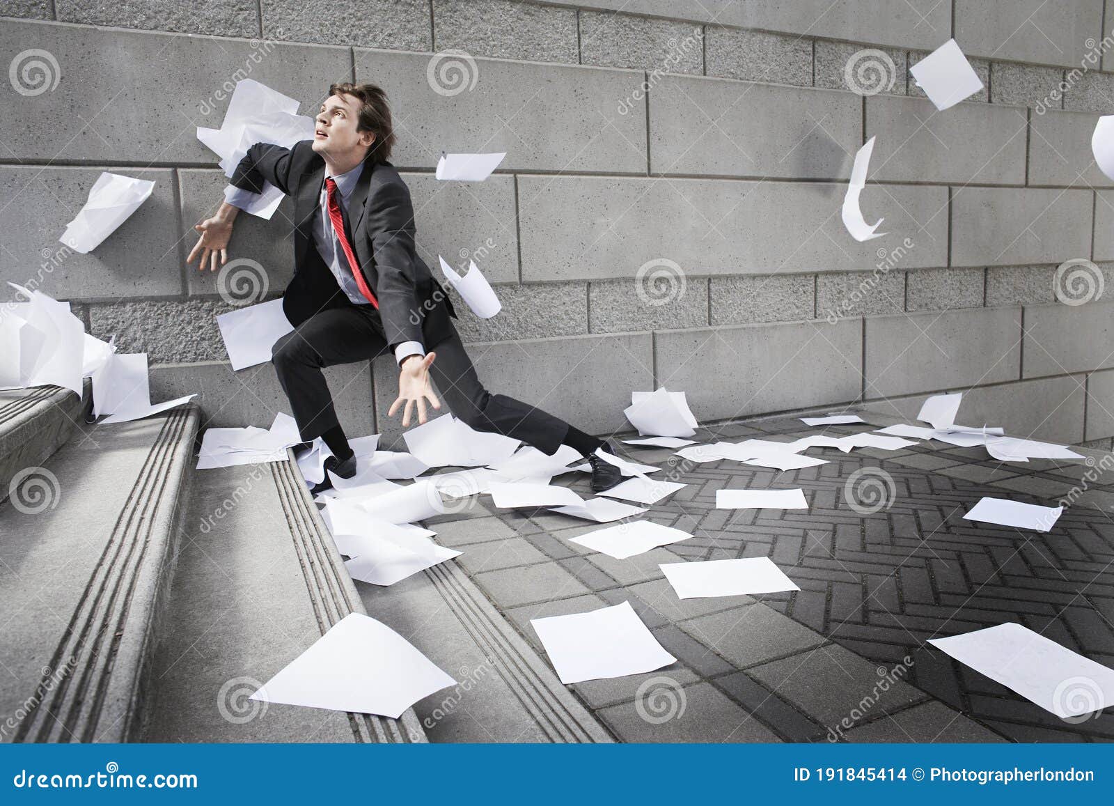 Busines Man Catching Falling Paperwork on Steps Stock Photo - Image of ...