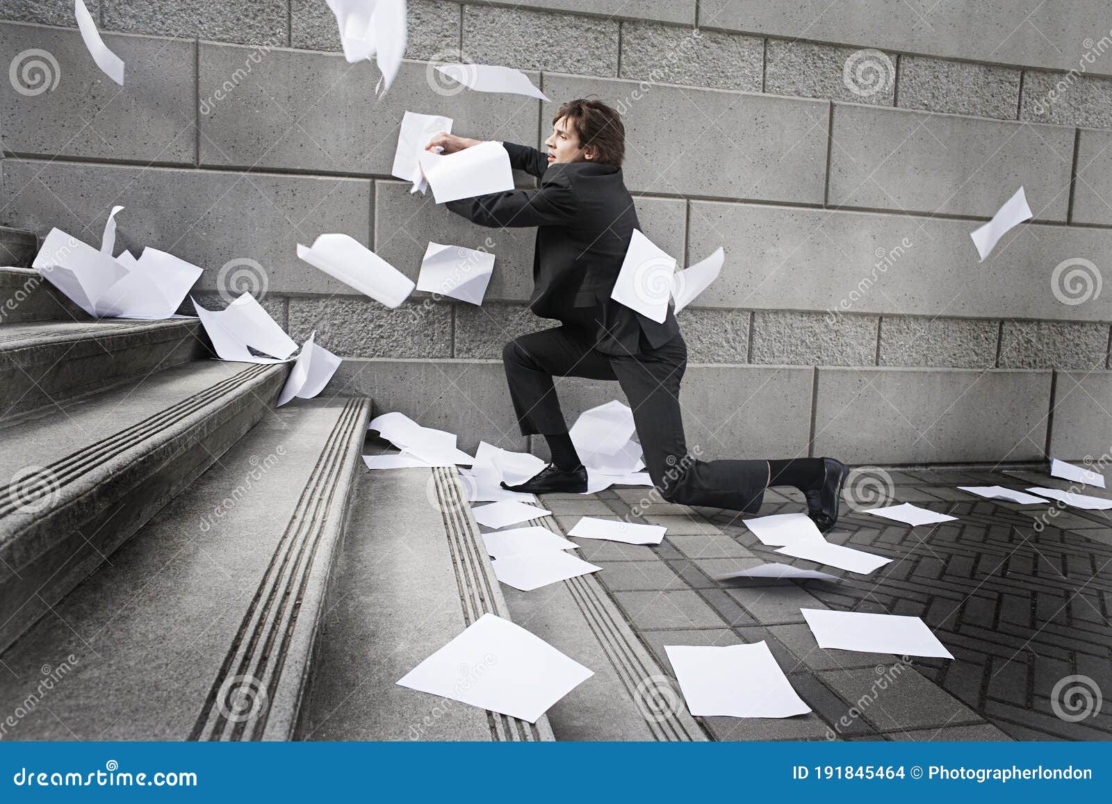 Busines Man Catching Falling Paperwork on Steps Stock Photo - Image of ...