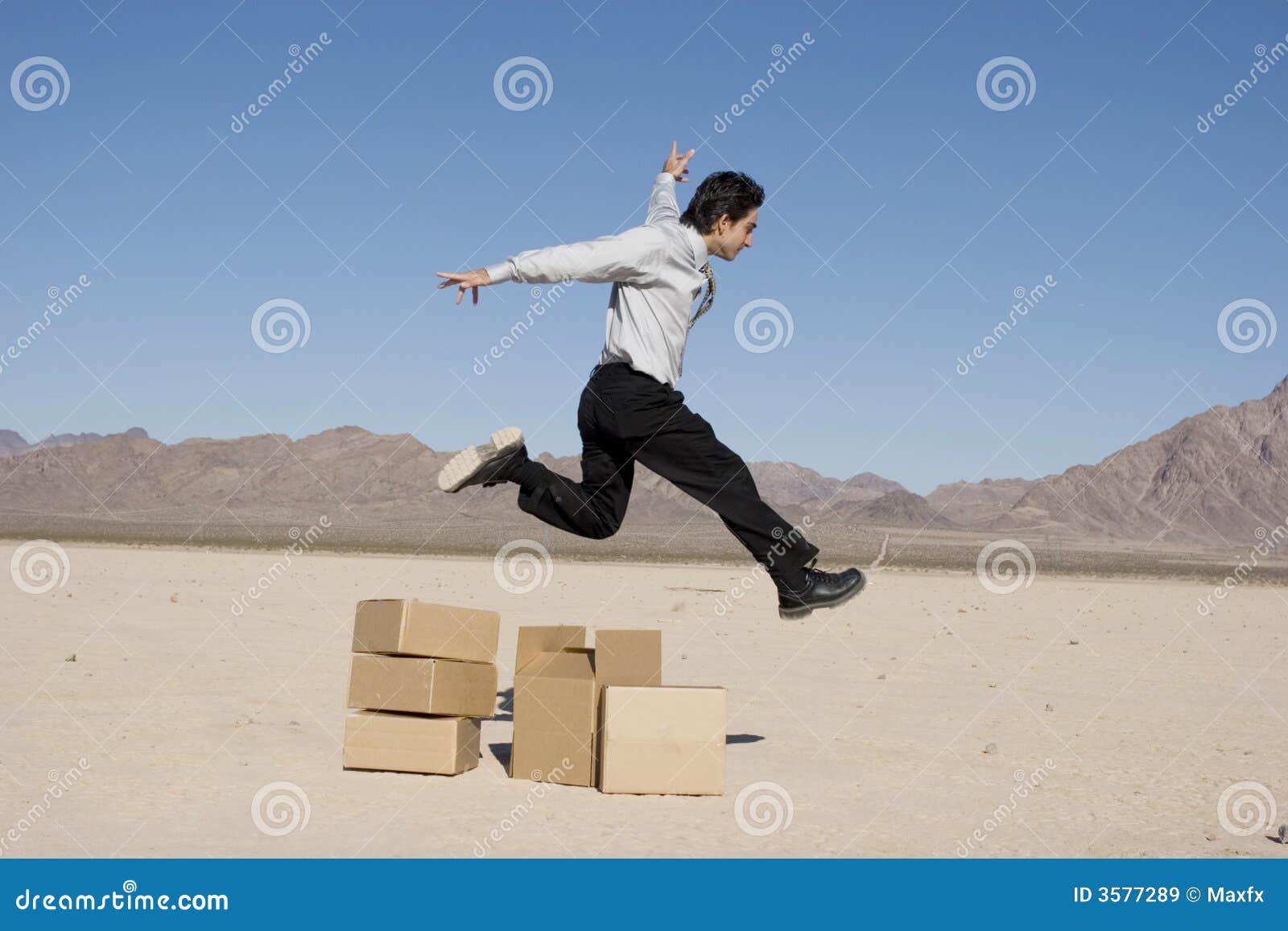 Businesman Jumping Over Boxes Stock Image - Image of businessman ...
