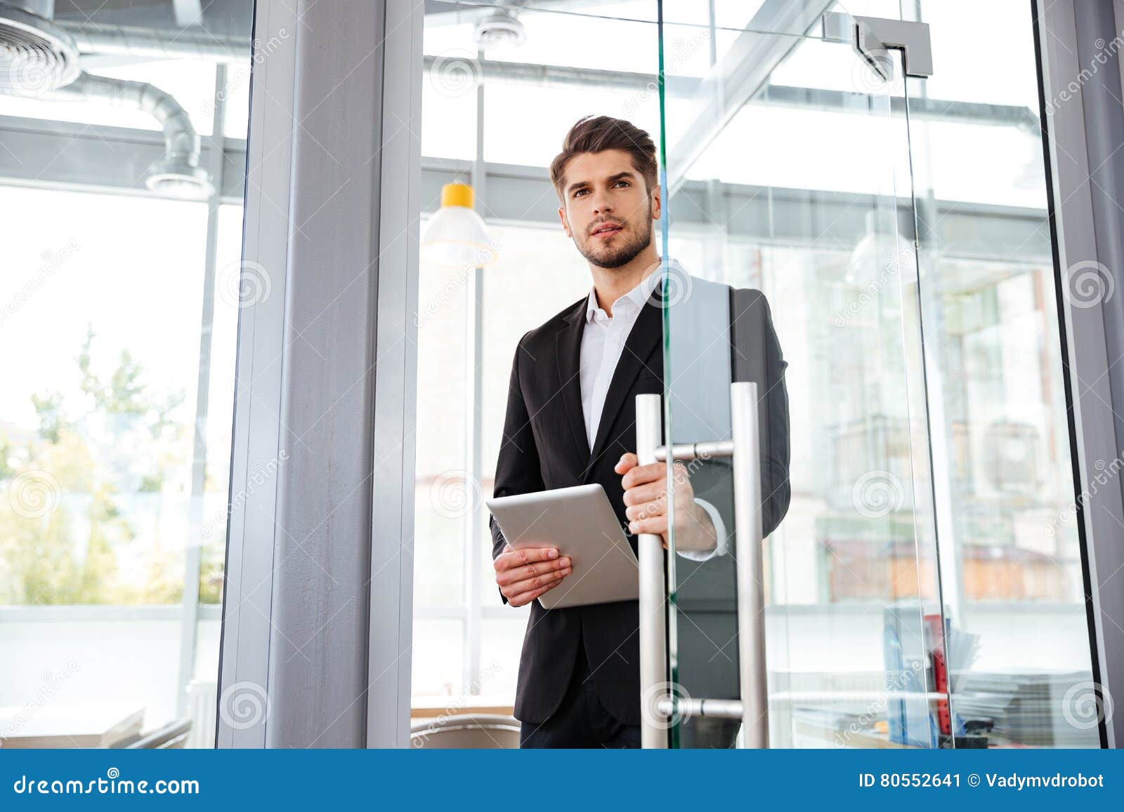 Businesman with Tablet Entering the Door in Office Stock Image - Image ...