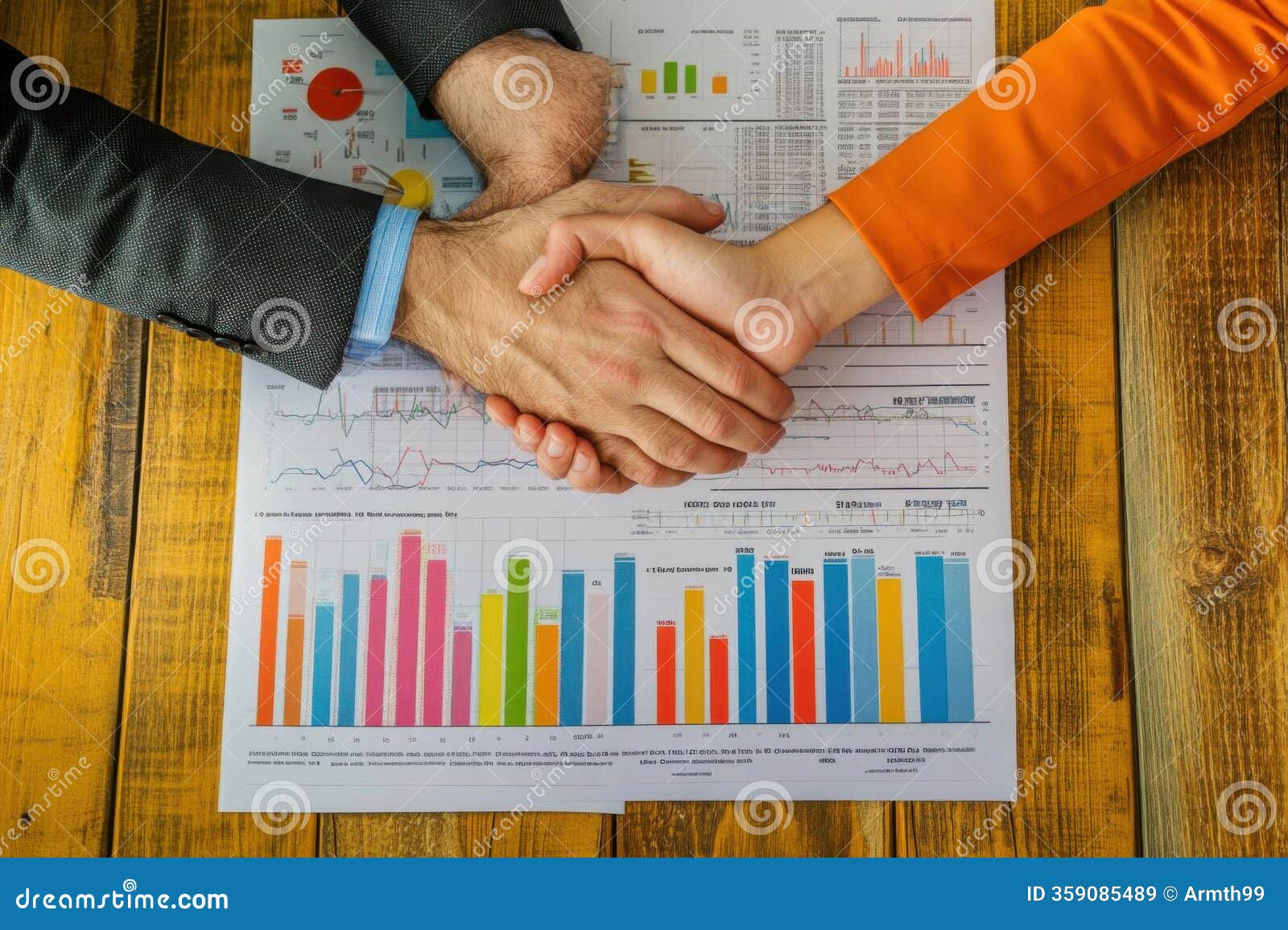 Business Agreement Shaking Hands Over Financial Charts, Graphs and Data ...