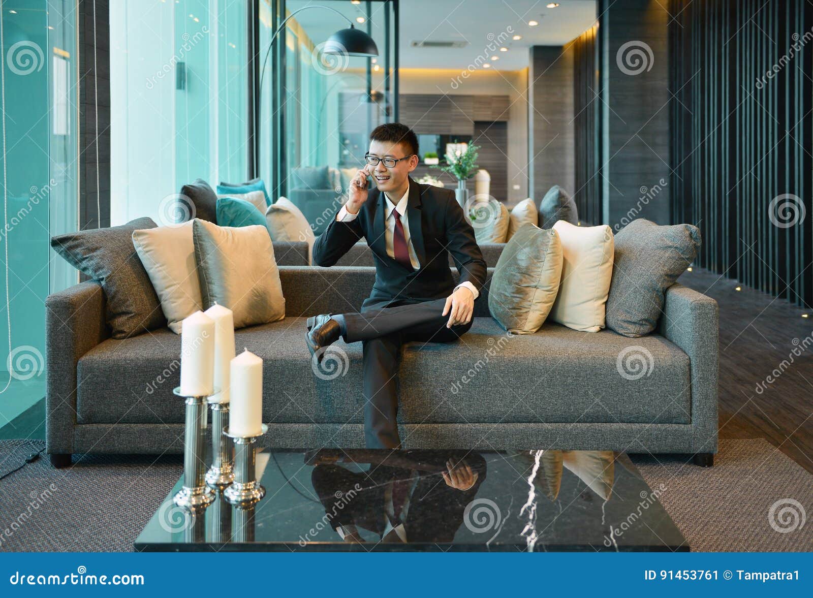 Business Asian Man Using a Smartphone on Sofa in Luxury Condo Stock ...