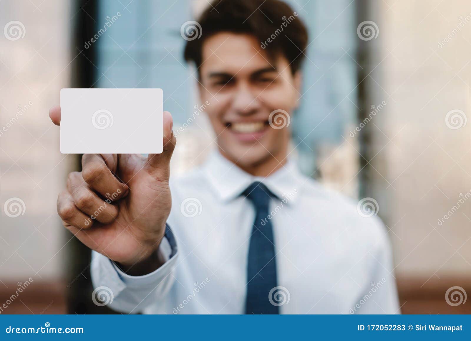 Business Card Mockup Image. Happy Young Businessman Presenting a White ... Business Card Mockup Image. Happy Young Businessman Presenting a White ...