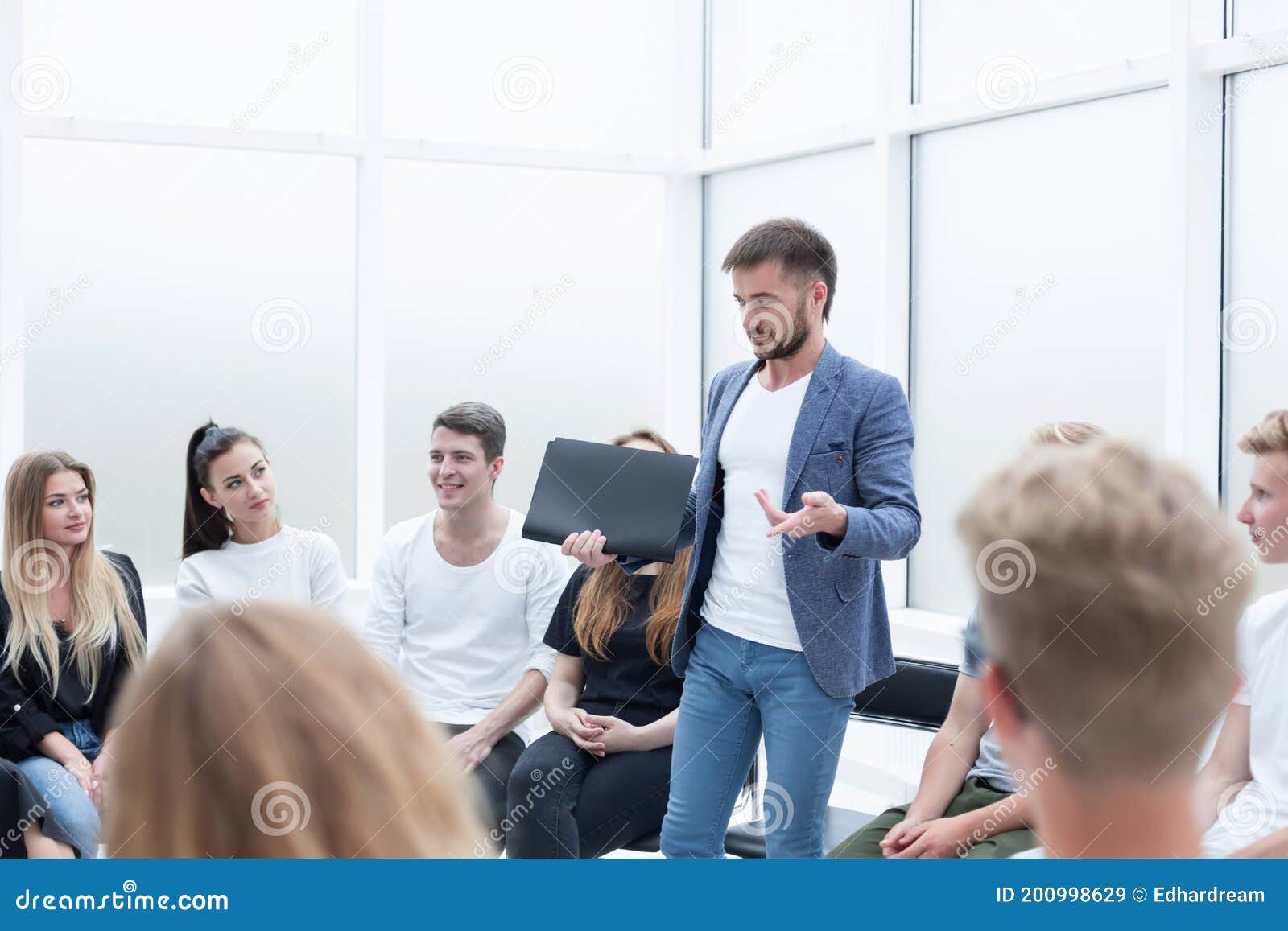 Business Coach Standing in a Circle of Young People. Stock Image ...