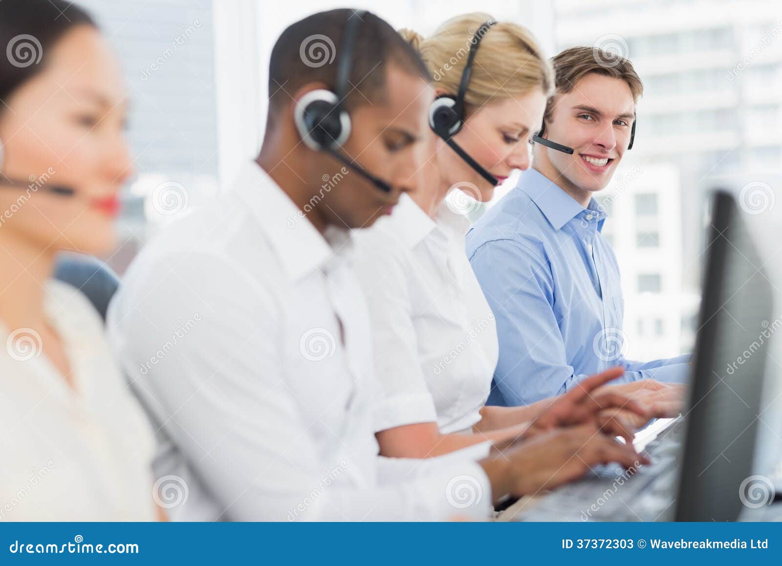 Business Colleagues with Headsets Using Computers at Desk Stock Image ...