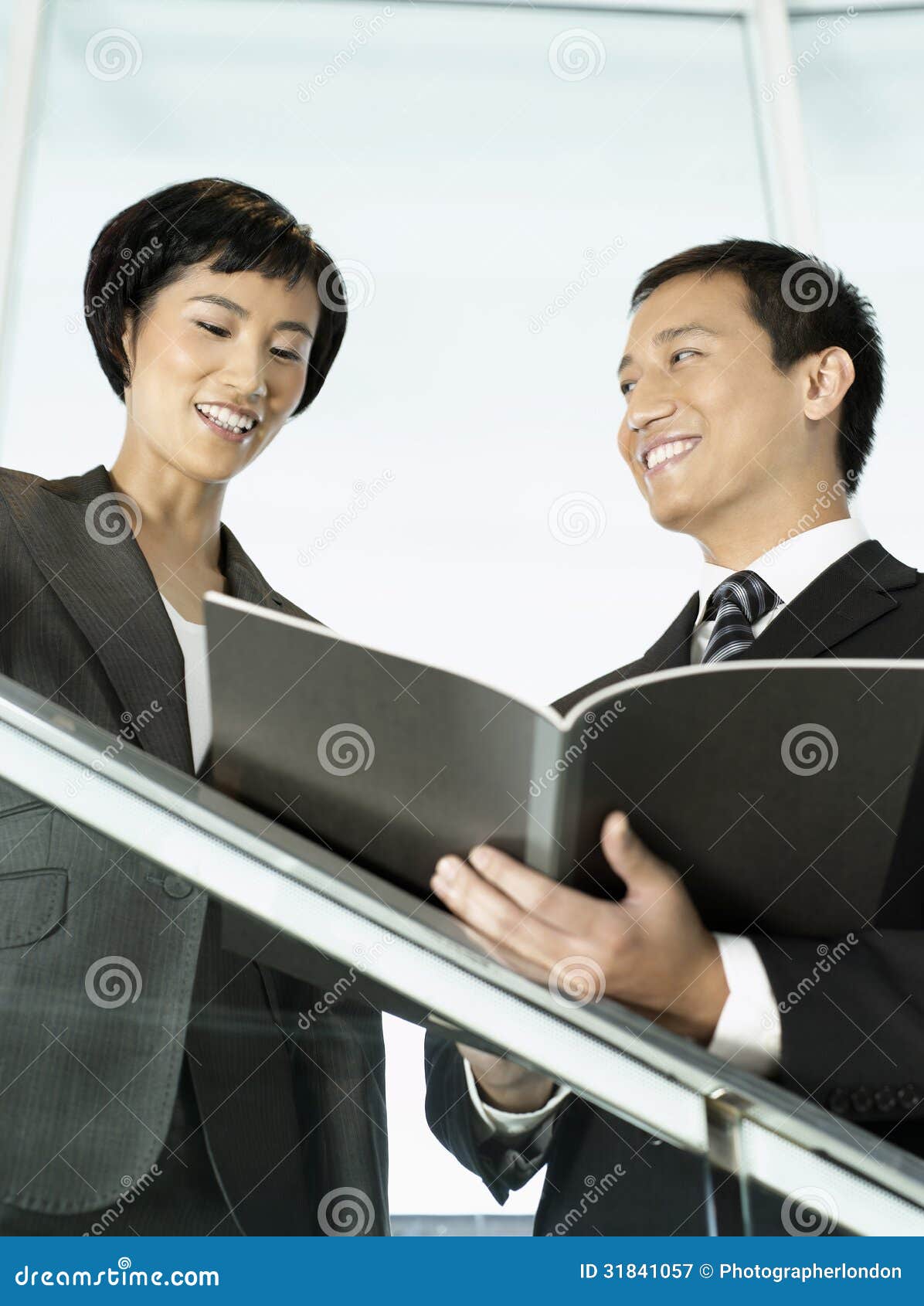 Business Colleagues Reviewing Documents on Stairs Stock Image - Image ...