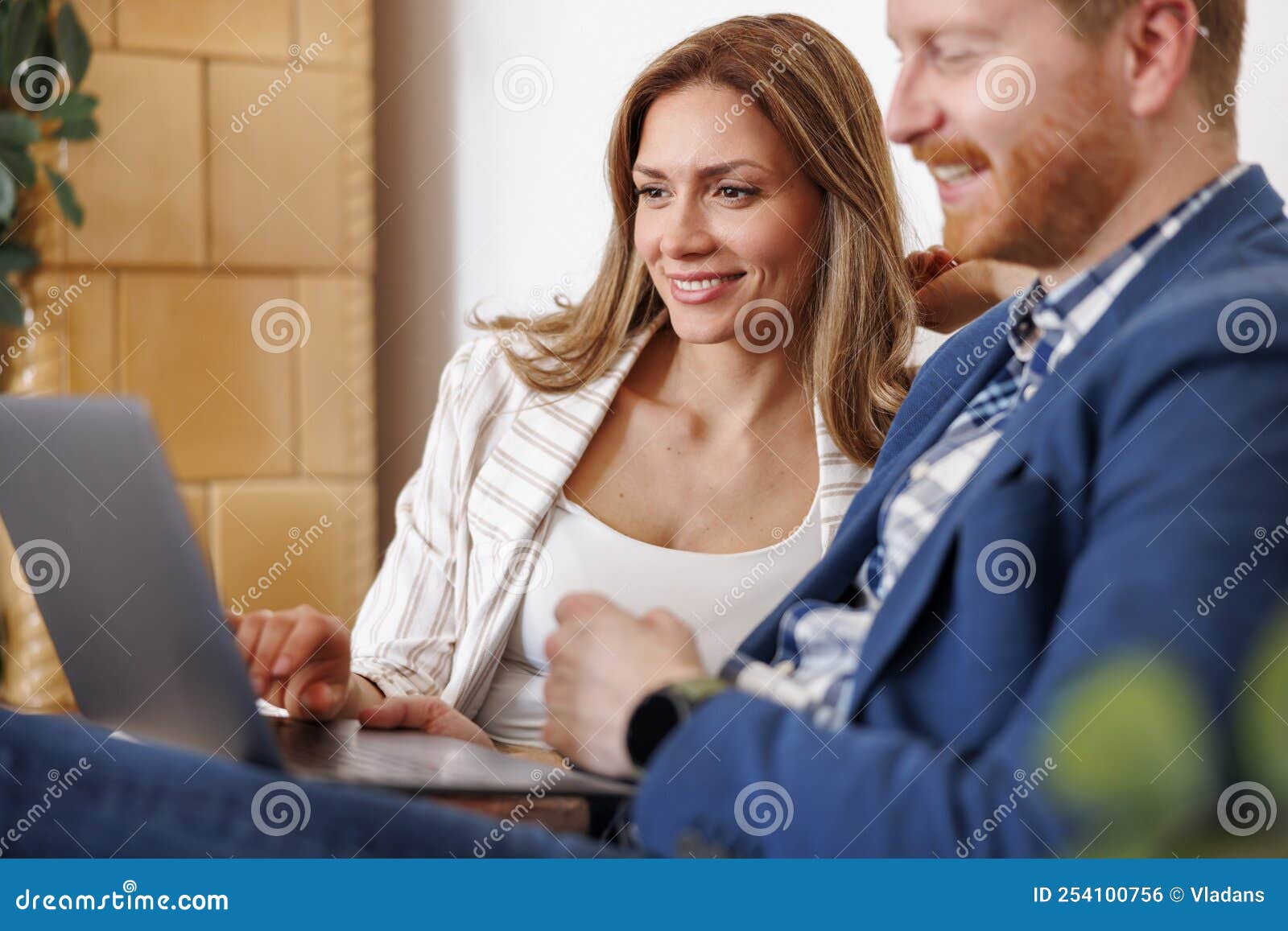 Colleagues Working Together Using Laptop Computer at the Office Stock ...