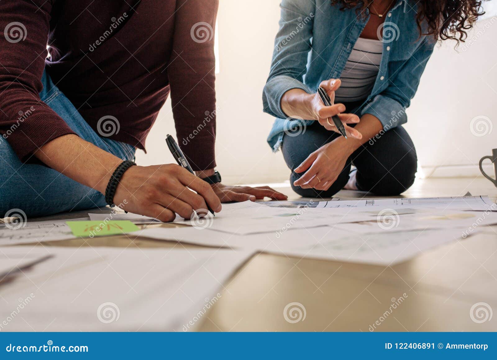Business Colleagues Sitting on the Floor and Discussing Work Wit Stock ... Business Colleagues Sitting on the Floor and Discussing Work Wit Stock ...