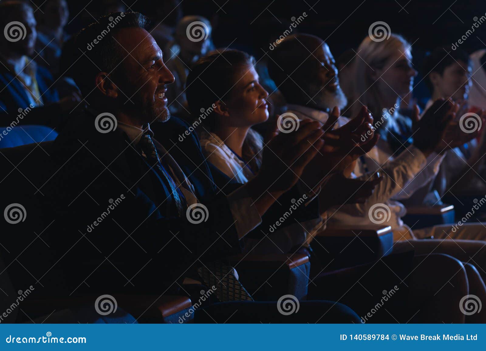 Business Colleagues Sitting and Watching Presentation with Audience and ...