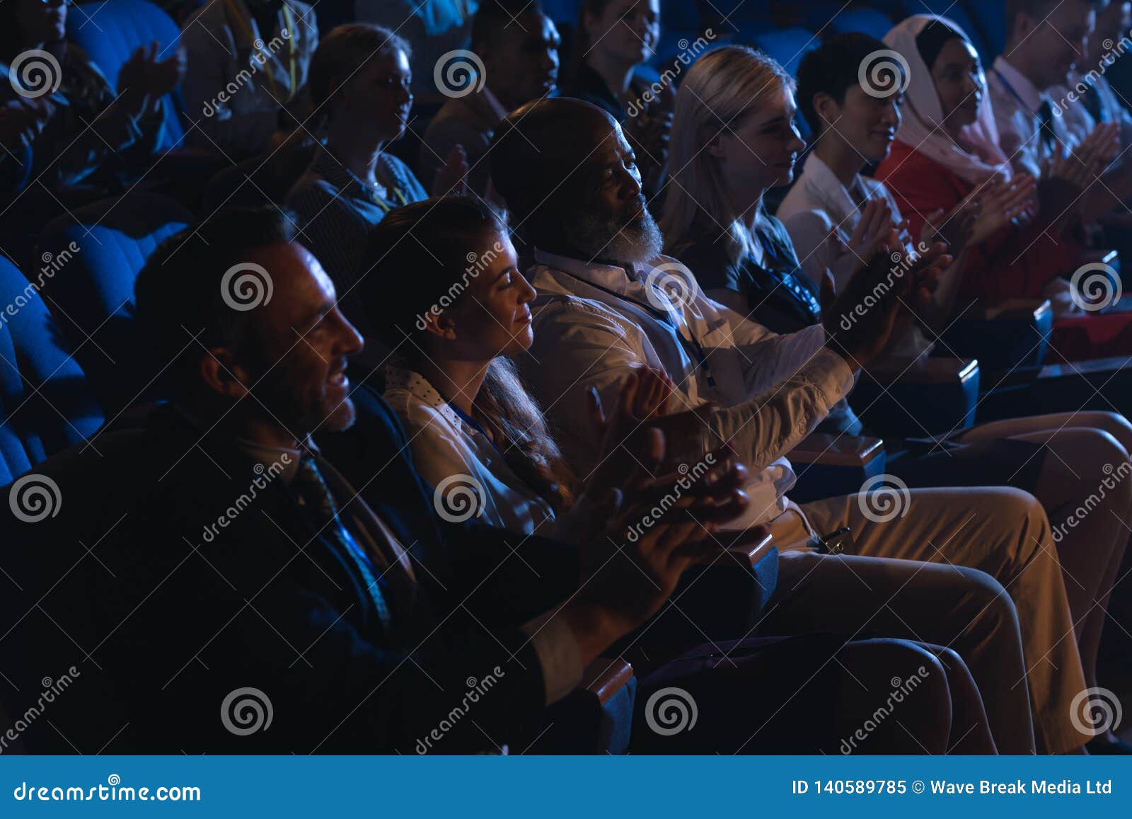Business Colleagues Sitting and Watching Presentation with Audience ...