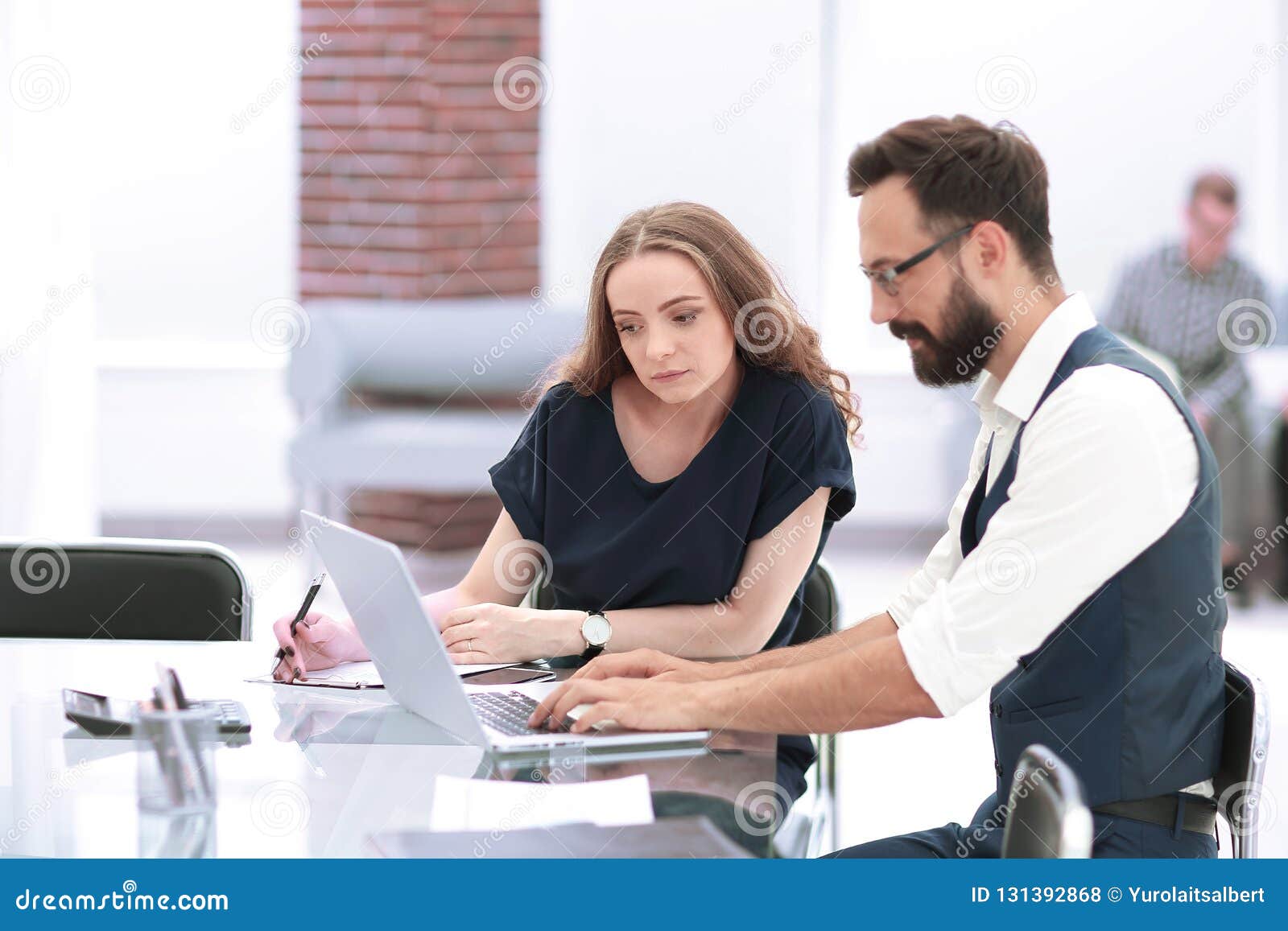 Business Colleagues Using a Laptop in the Workplace. Stock Photo ...
