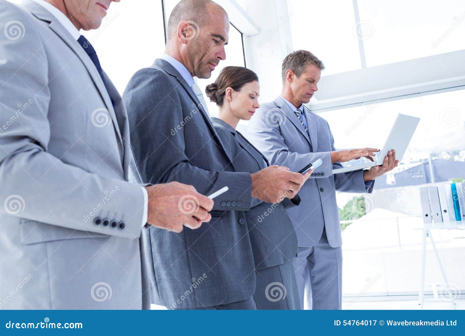 Business Colleagues Using Their Multimedia Devices Stock Image - Image ...