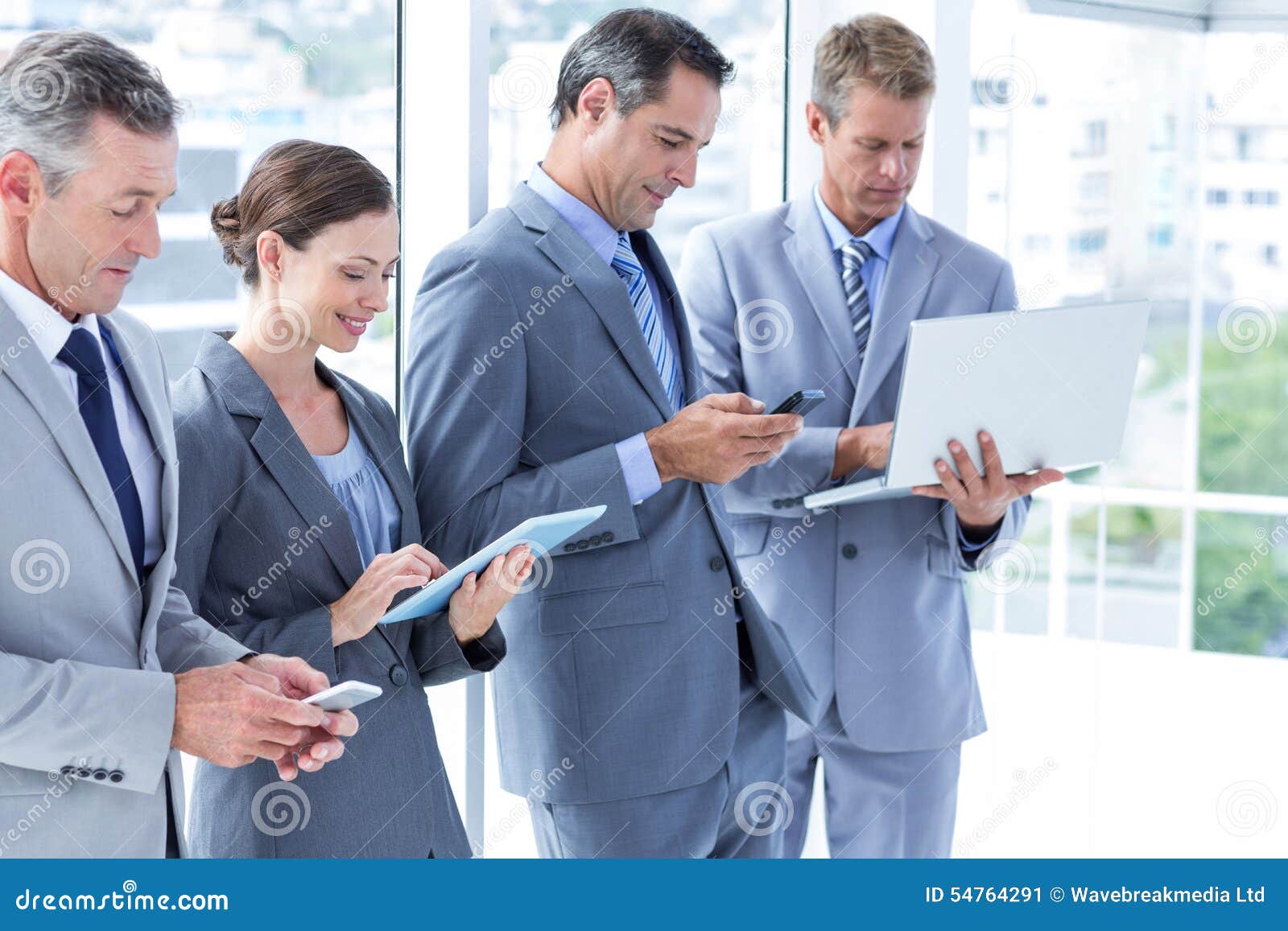 Business Colleagues Using Their Multimedia Devices Stock Image - Image ...