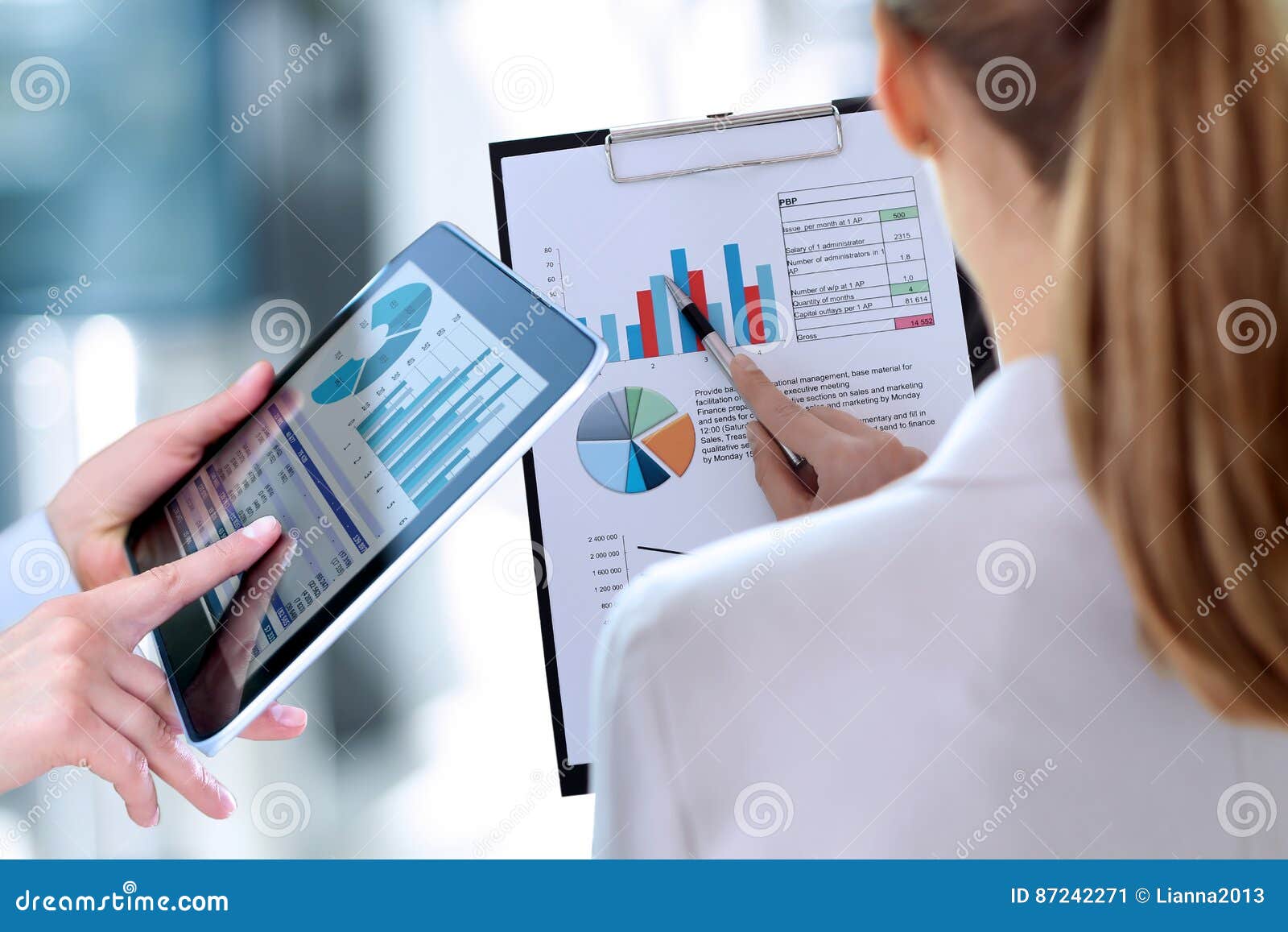 Business Colleagues Working and Analyzing Financial Figures on a Graphs ...