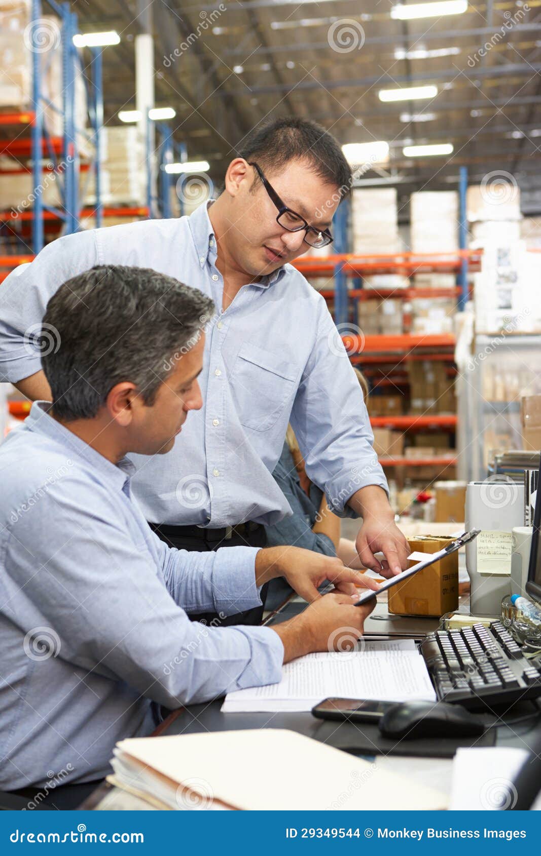 Business Colleagues Working at Desk in Warehouse Stock Photo - Image of ...