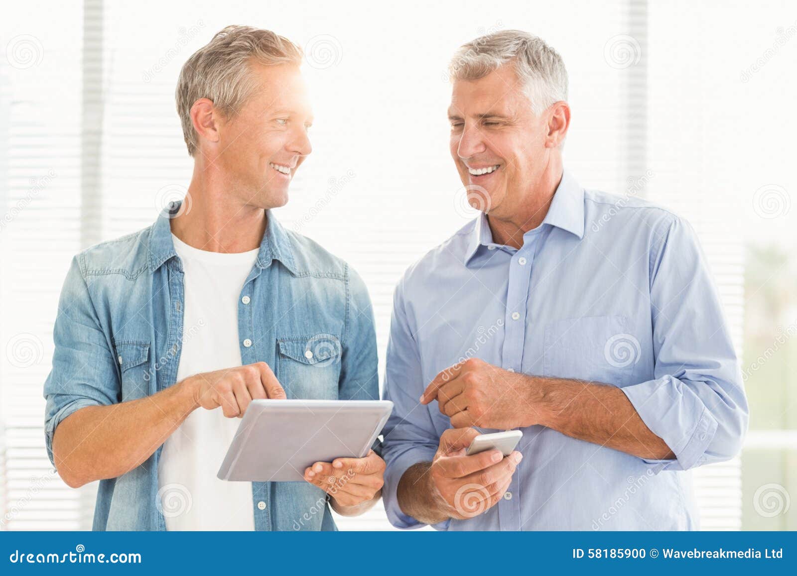 Business Colleagues Working on Tablet and Phone Stock Photo - Image of ... Business Colleagues Working on Tablet and Phone Stock Photo - Image of ...