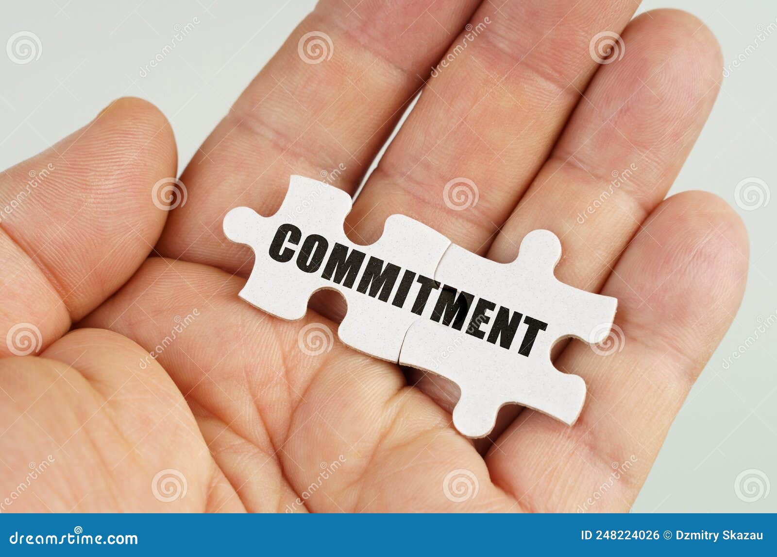In the Hand of a Man are Puzzles with the Inscription - COMMITMENT ...