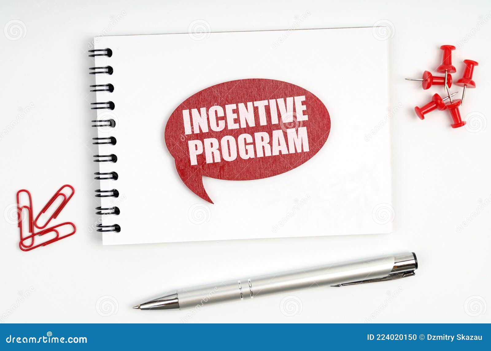 On the Table There are Stationery, a Notebook and a Red Sign with the ...