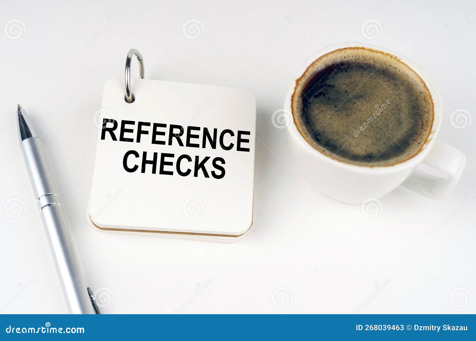 On a White Surface, a Cup of Coffee, a Pen and a Notepad with the ...