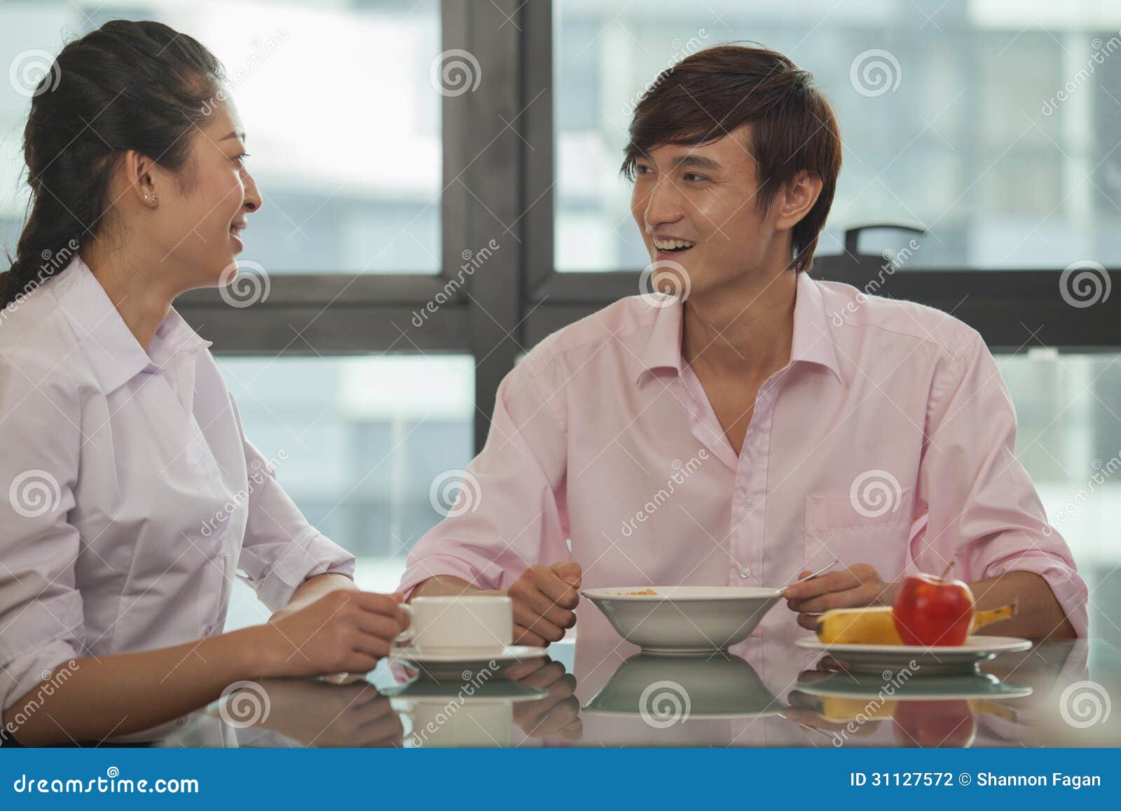 Business Couple Smiling and Eating Breakfast Together Stock Photo ...