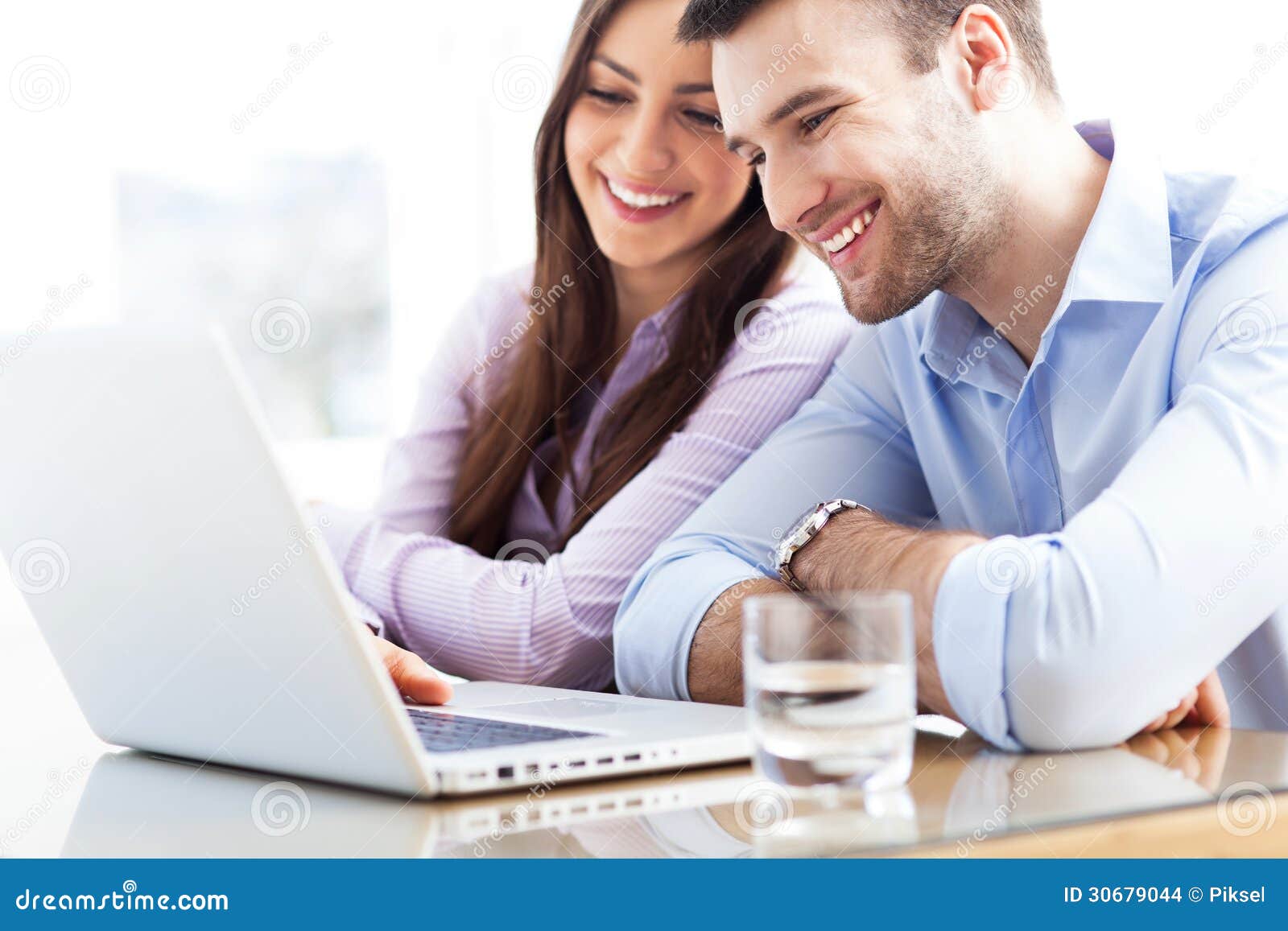 Business Couple Using Laptop Stock Photo - Image of toothy ...