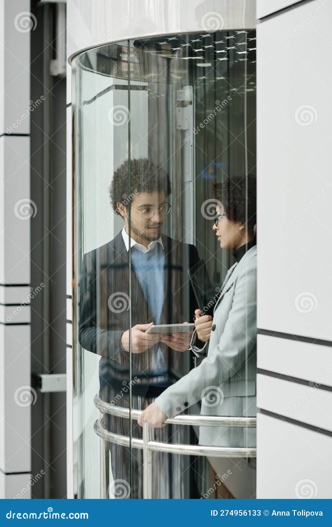 Business Couple Using Tablet Pc in Elevator Stock Image - Image of ...