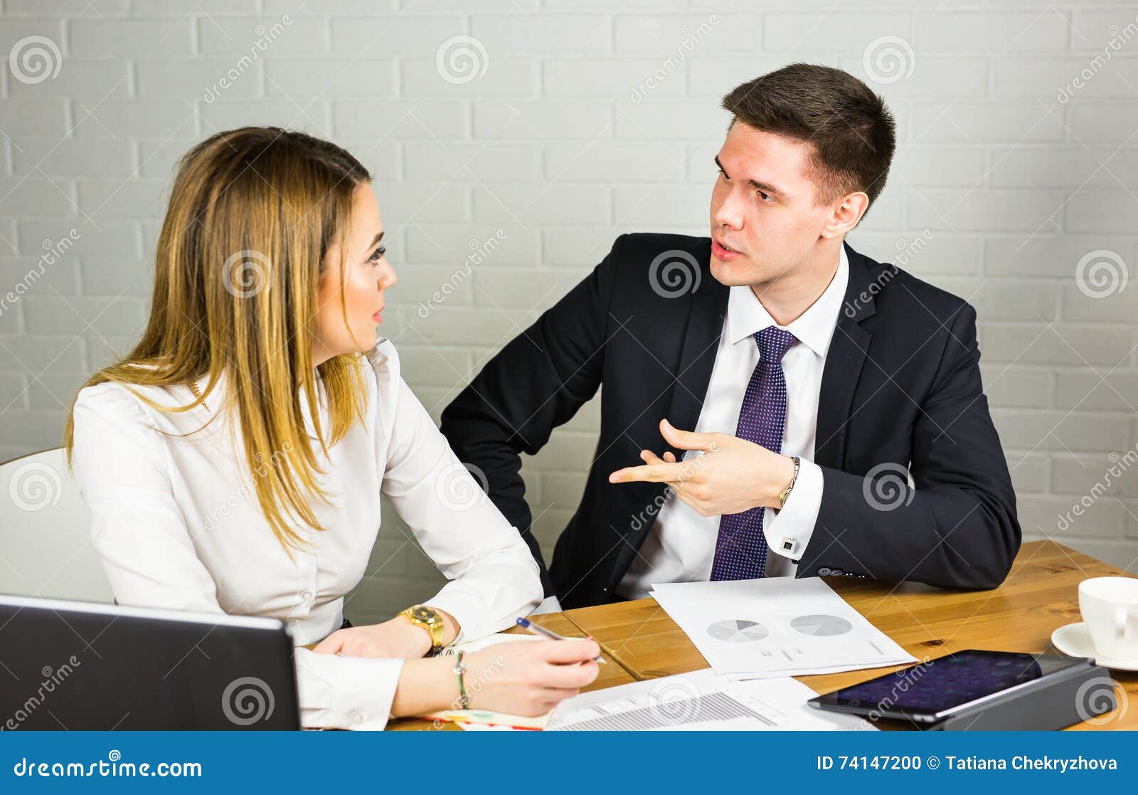 Business Couple Working Together on Project at Modern Startup Office ...