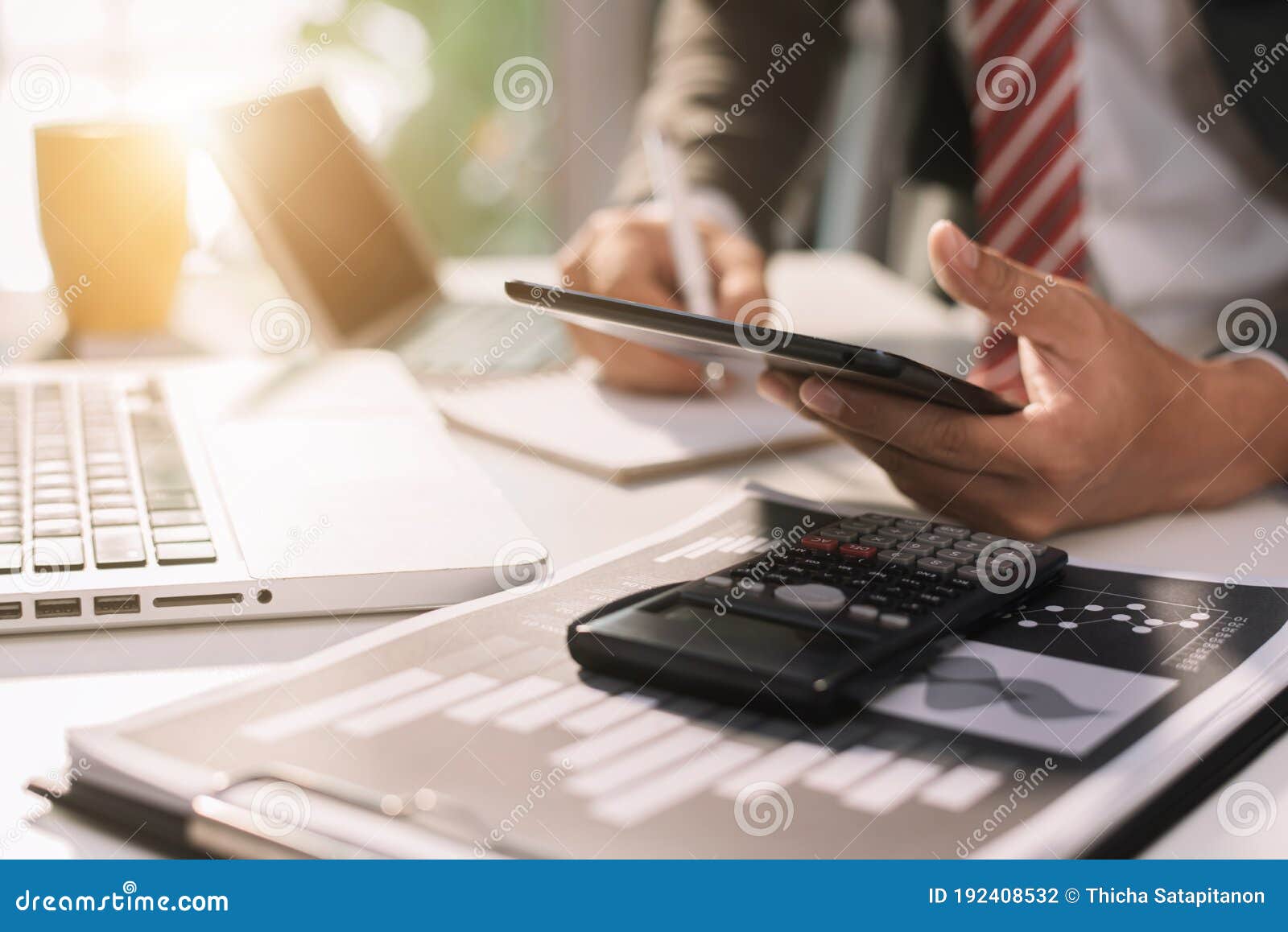 Business Documents on Office Desk with Laptop and Smart Phone and Graph ...
