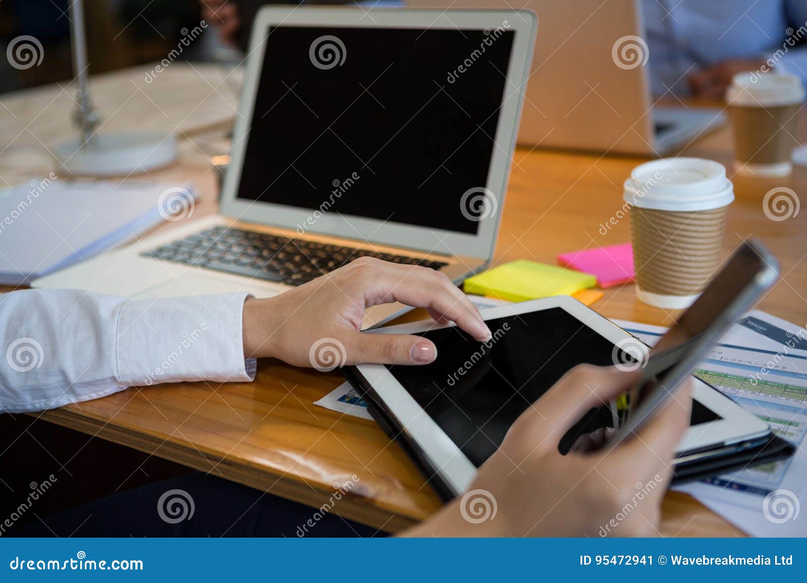 Business Executive Using Digital Tablet and Mobile Phone at Desk Stock ...