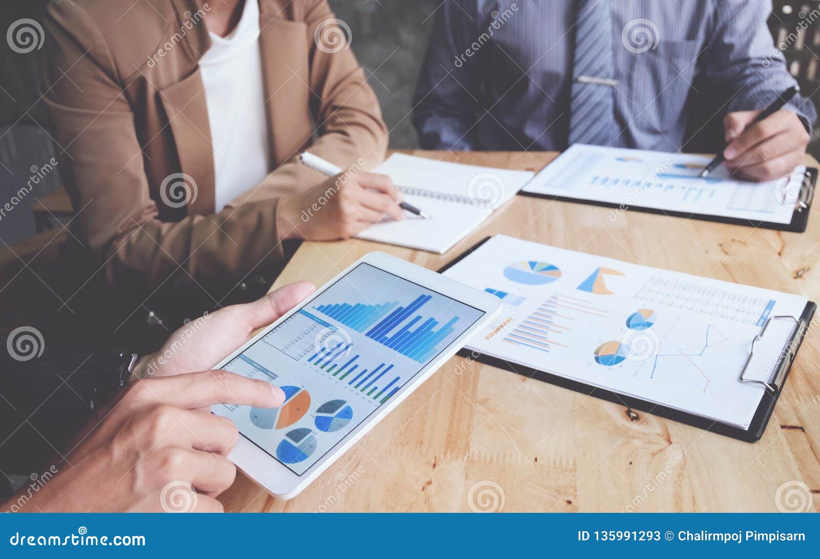 Business Executives Discussing Documents and Ideas at Meeting in a ...