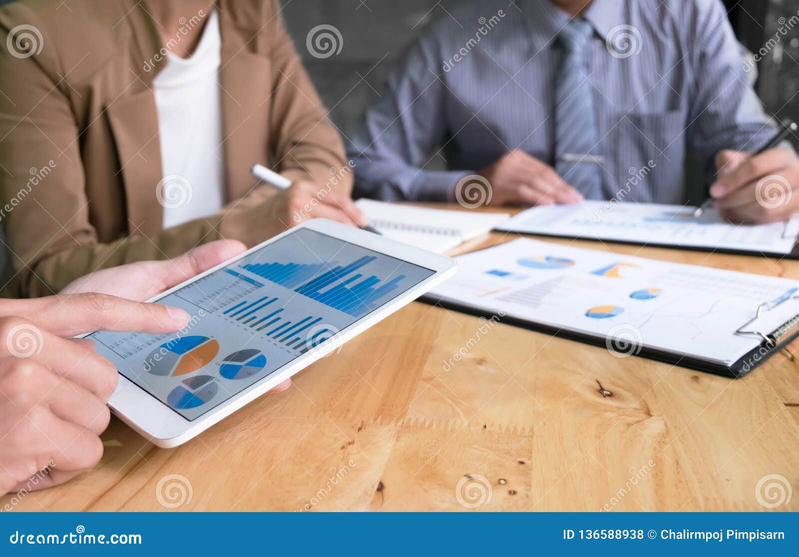 Business Executives Discussing Documents and Ideas at Meeting in a ...