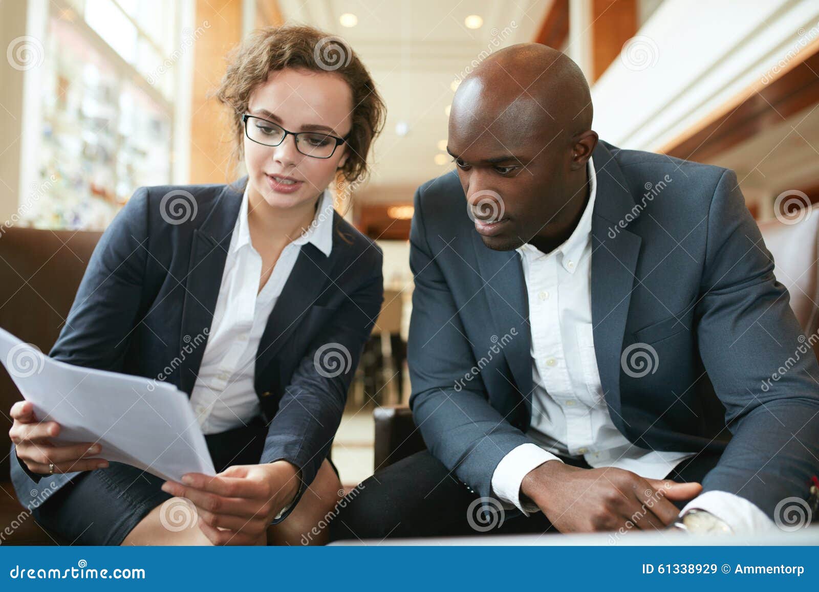 Business Executives Going through Papers in Lobby Stock Image - Image ...