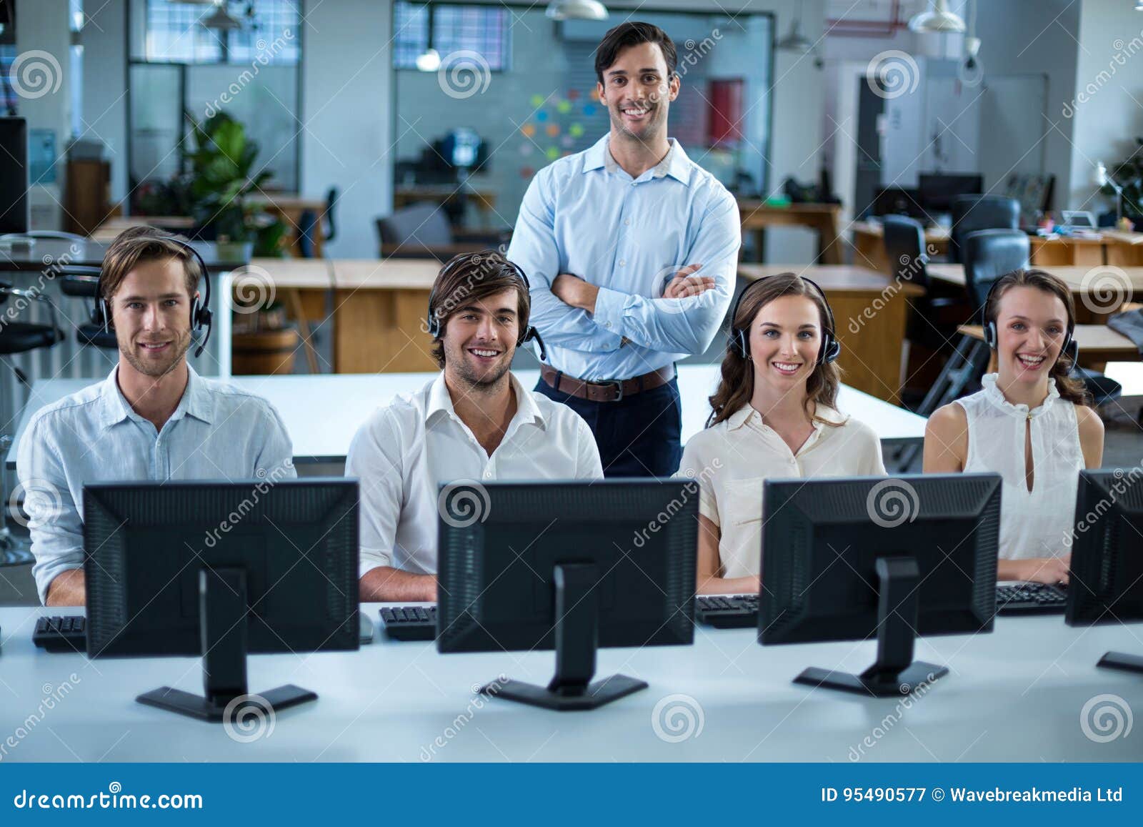 Business Executives with Headsets Using Computer in Office Stock Image ...