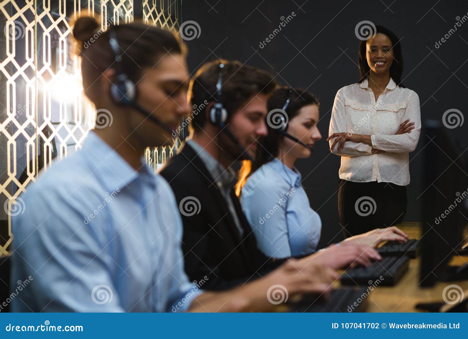 Business Executives with Headsets Using Computers at Desk Stock Photo ...