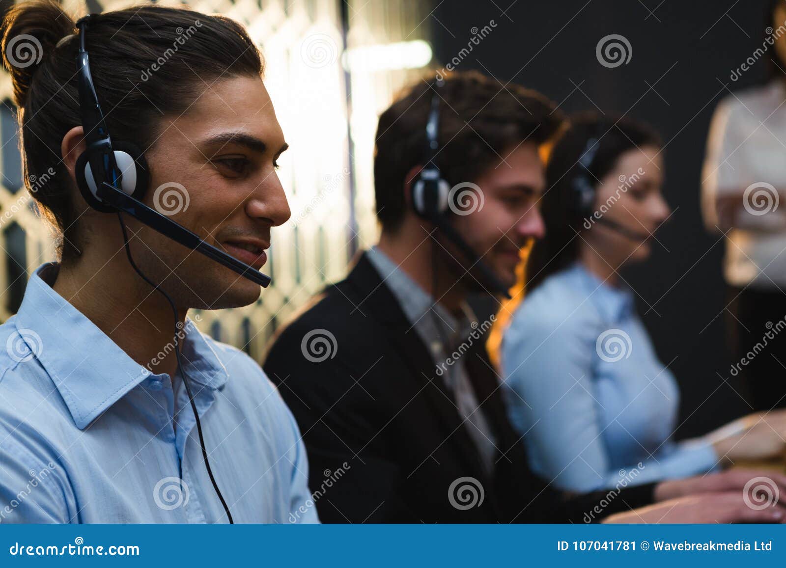 Business Executives with Headsets Using Computers at Desk Stock Image ...