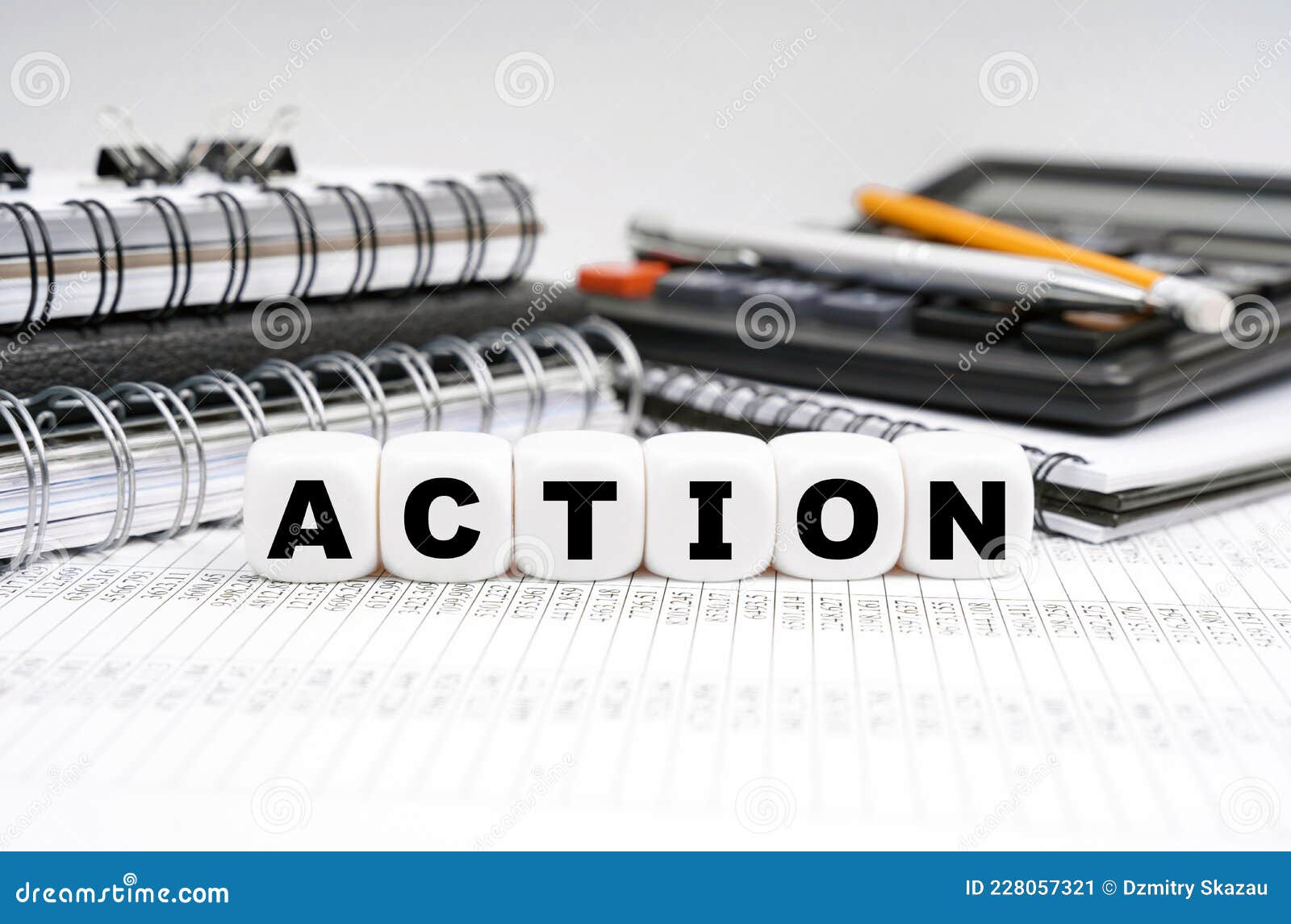 On the Table, among Office Objects, Cubes with the Inscription - ACTION ...