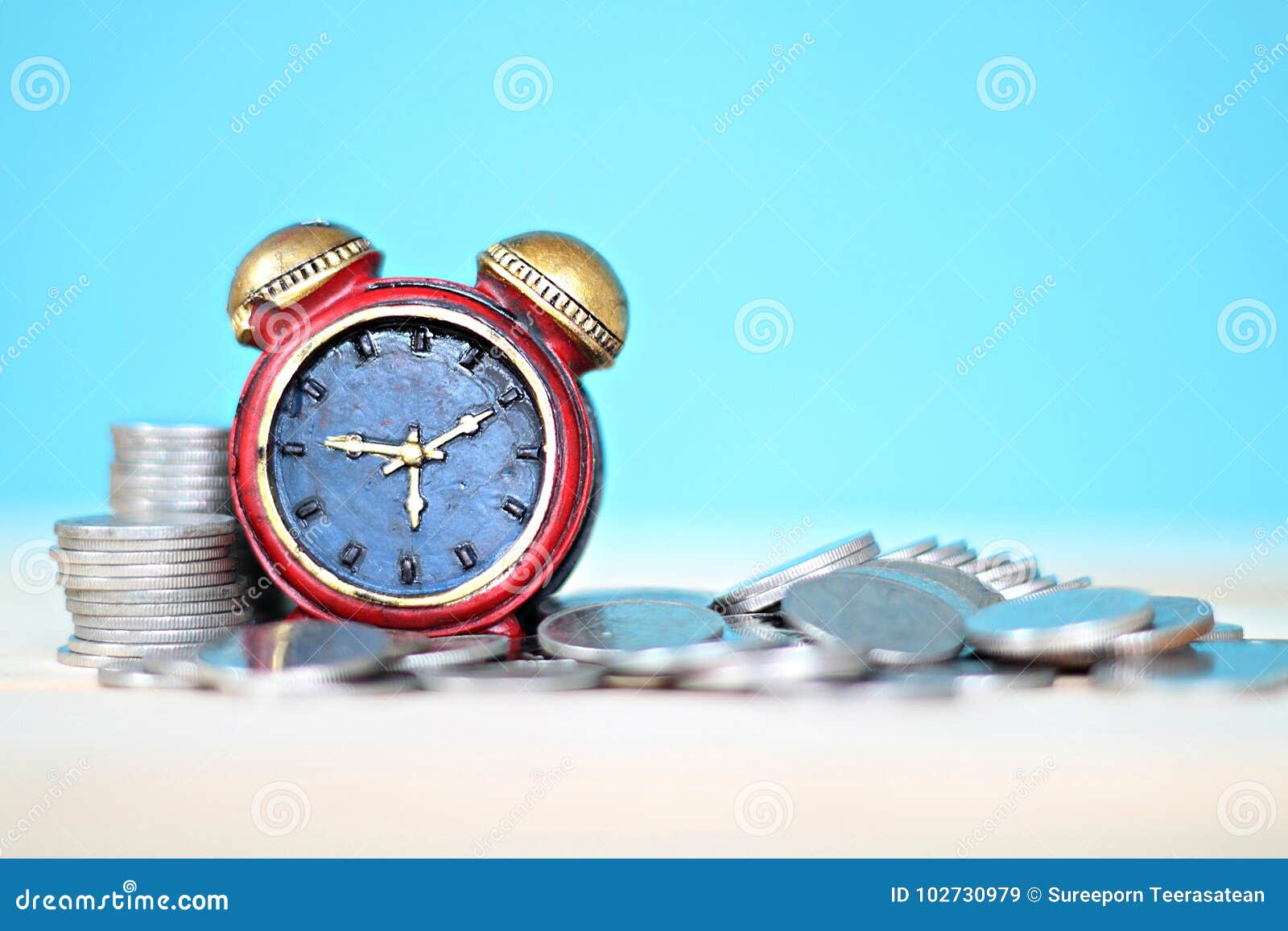 Miniature Clock and Coins Stack on Desk Table Stock Image - Image of ...