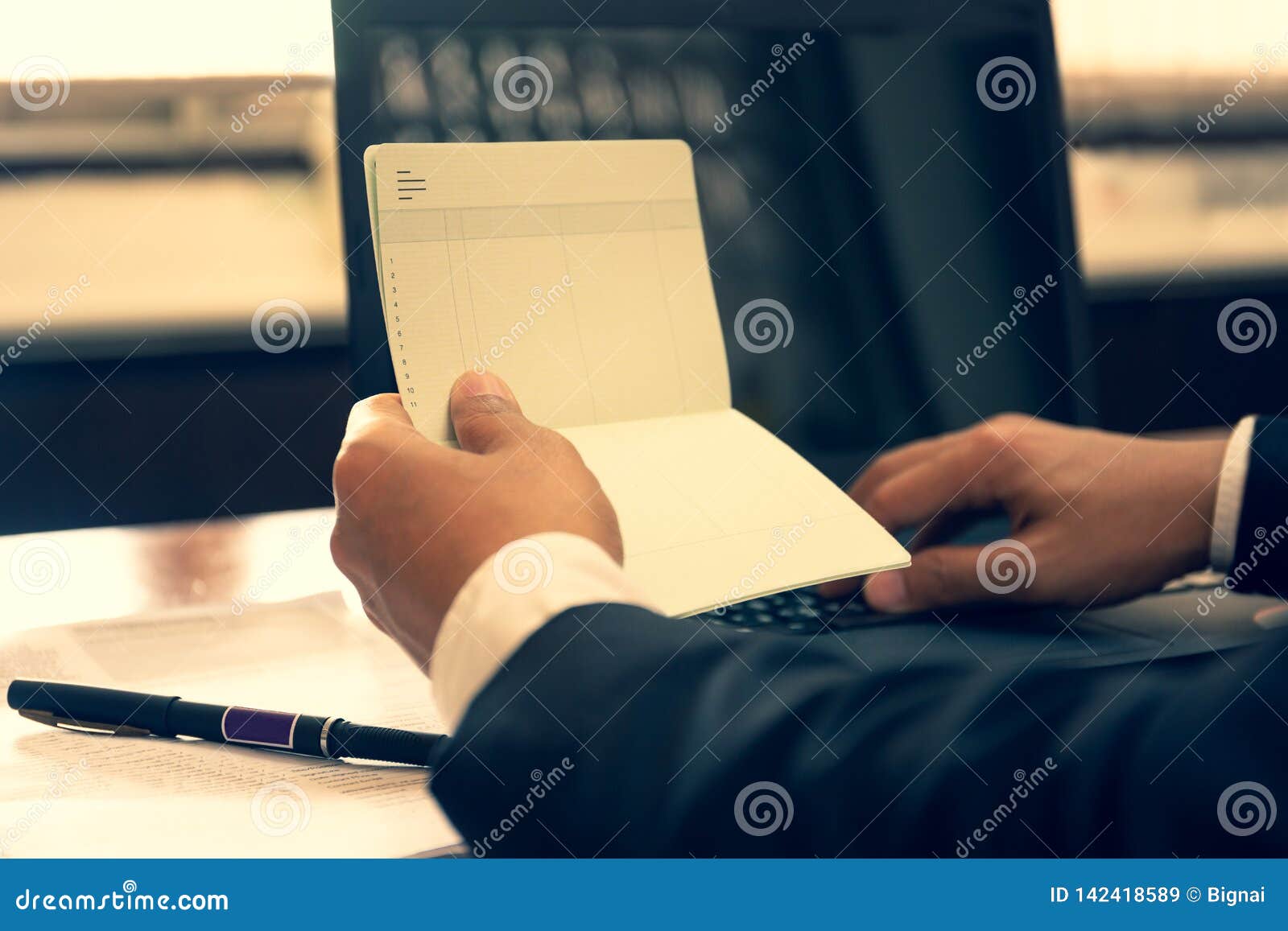 Business Financial Hand Hold Book Statement and Work with Laptop. Stock ...