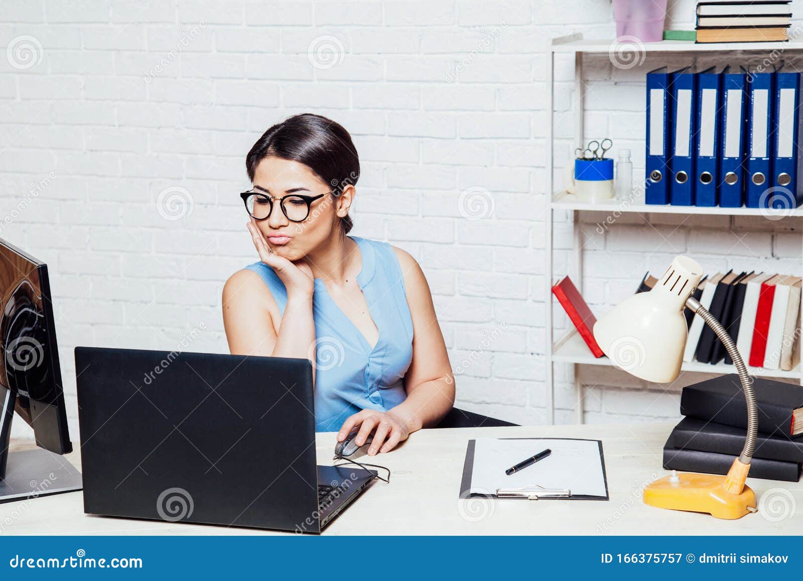 Business Girl Sits in an Office Behind a Desk with a Computer Stock ...
