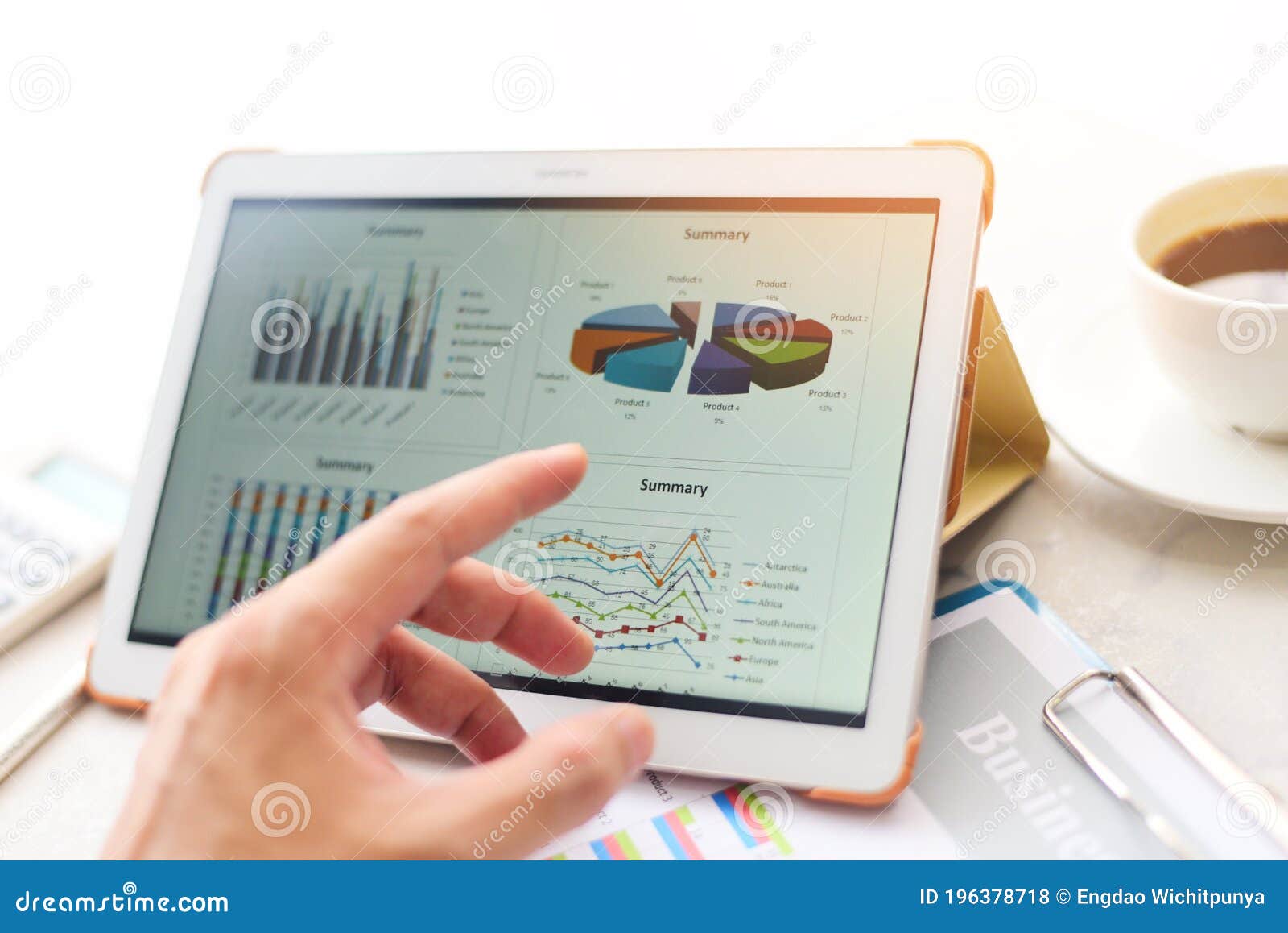 Business Graphs Chart on a Tablet Computer Technology on the Table with ...