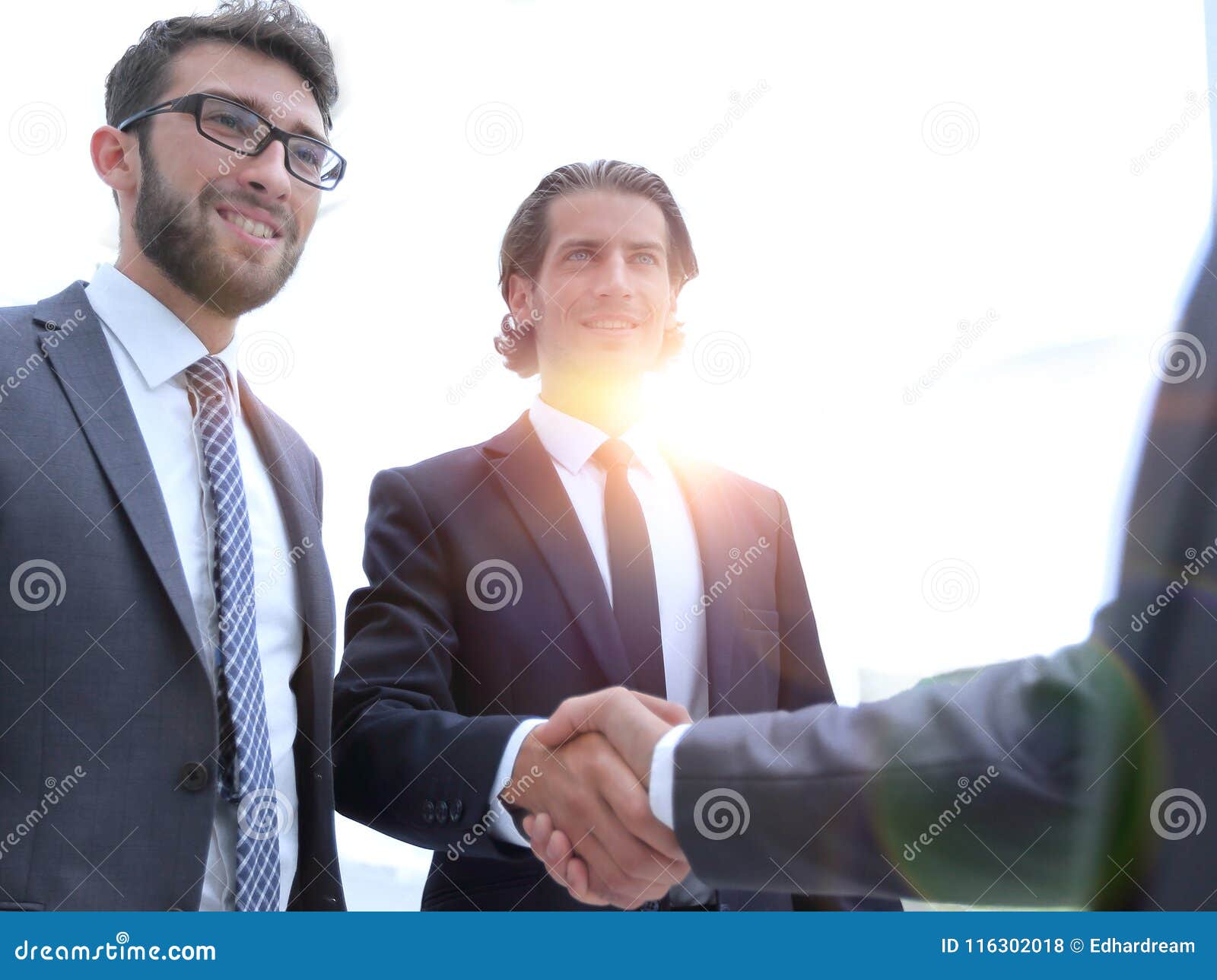 Business Group Welcomes Partner with a Handshake Stock Photo - Image of ...