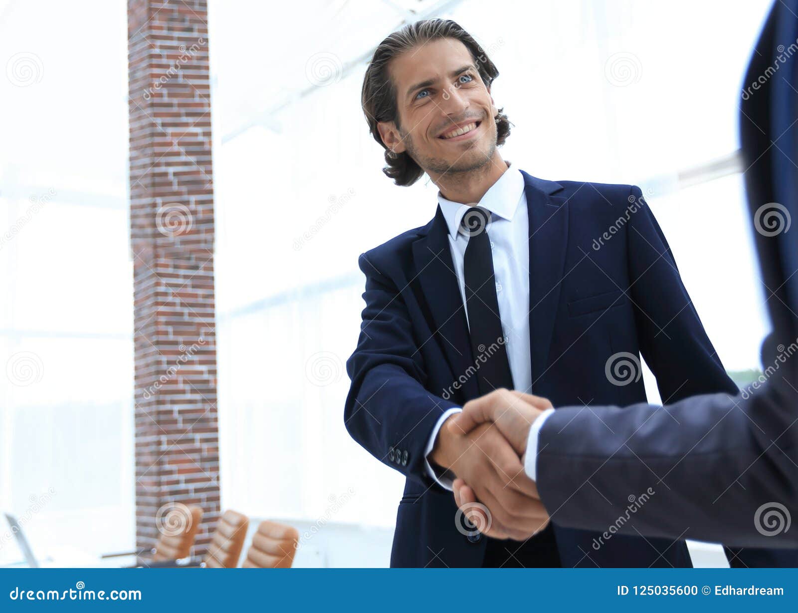 Business Group Welcomes Partner with a Handshake Stock Photo - Image of ...