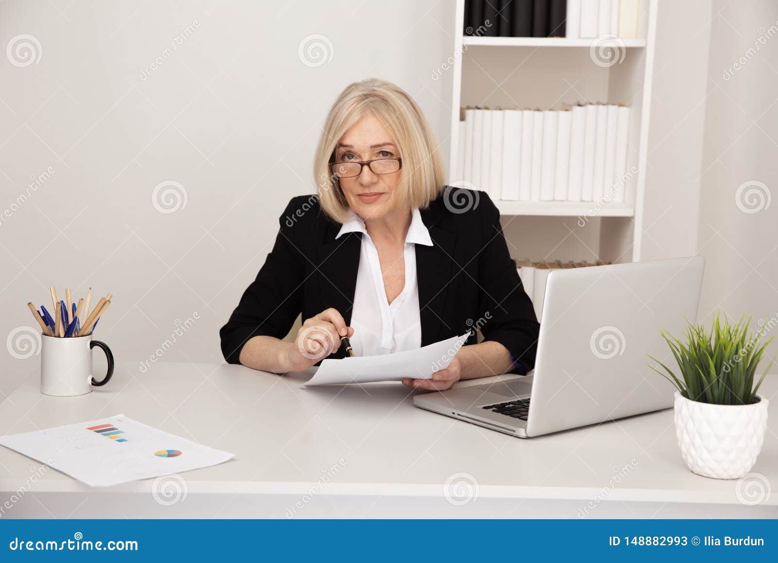 Business Lady in Office Holding Paper Documents and Smiling. Stock ...