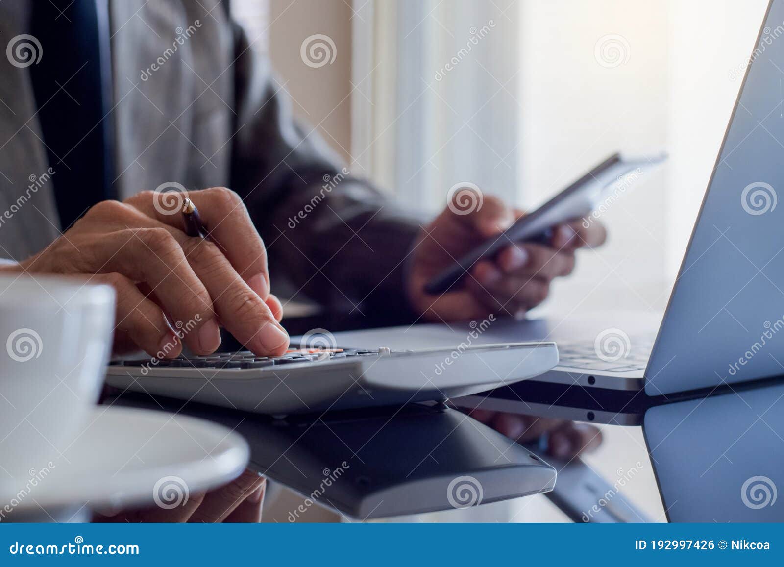 Business Man Hand Using Mobile Smart Phone and Calculator, Work on ...