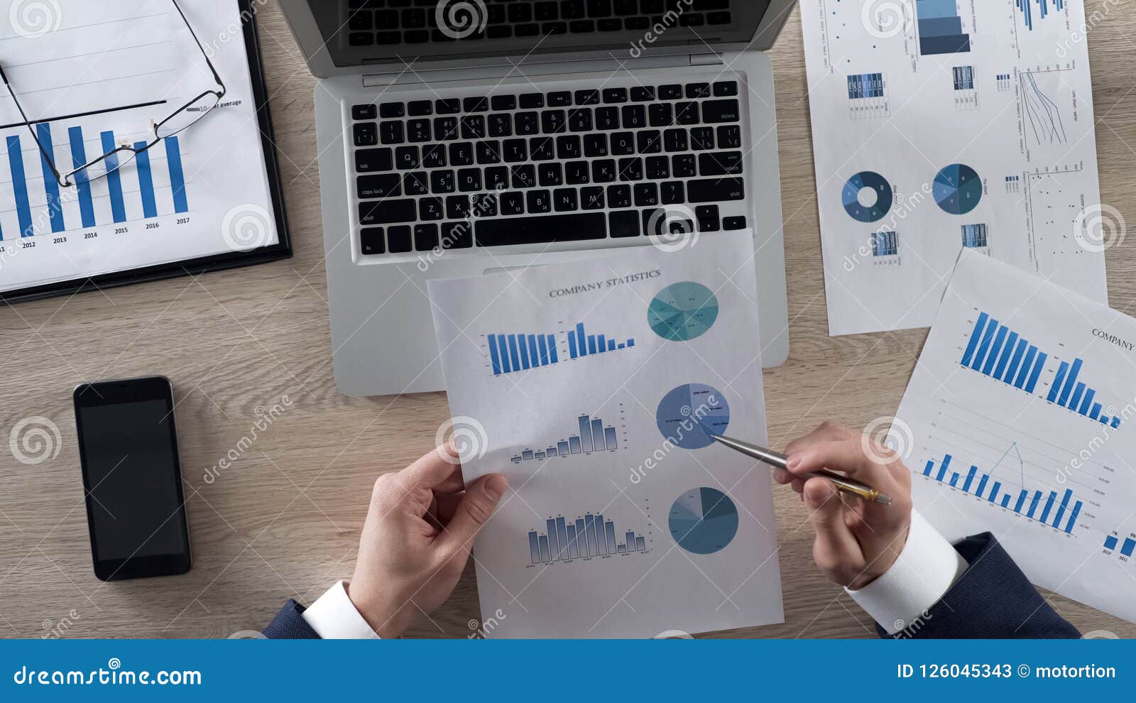 Business Man Analyzing Company Statistics Comparing it with Data on ...