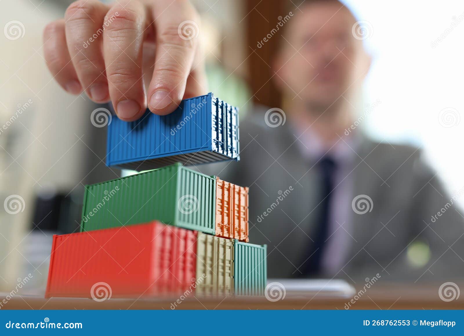 Business Man Arranging Stack of Cargo Containers on His Office Desk ...